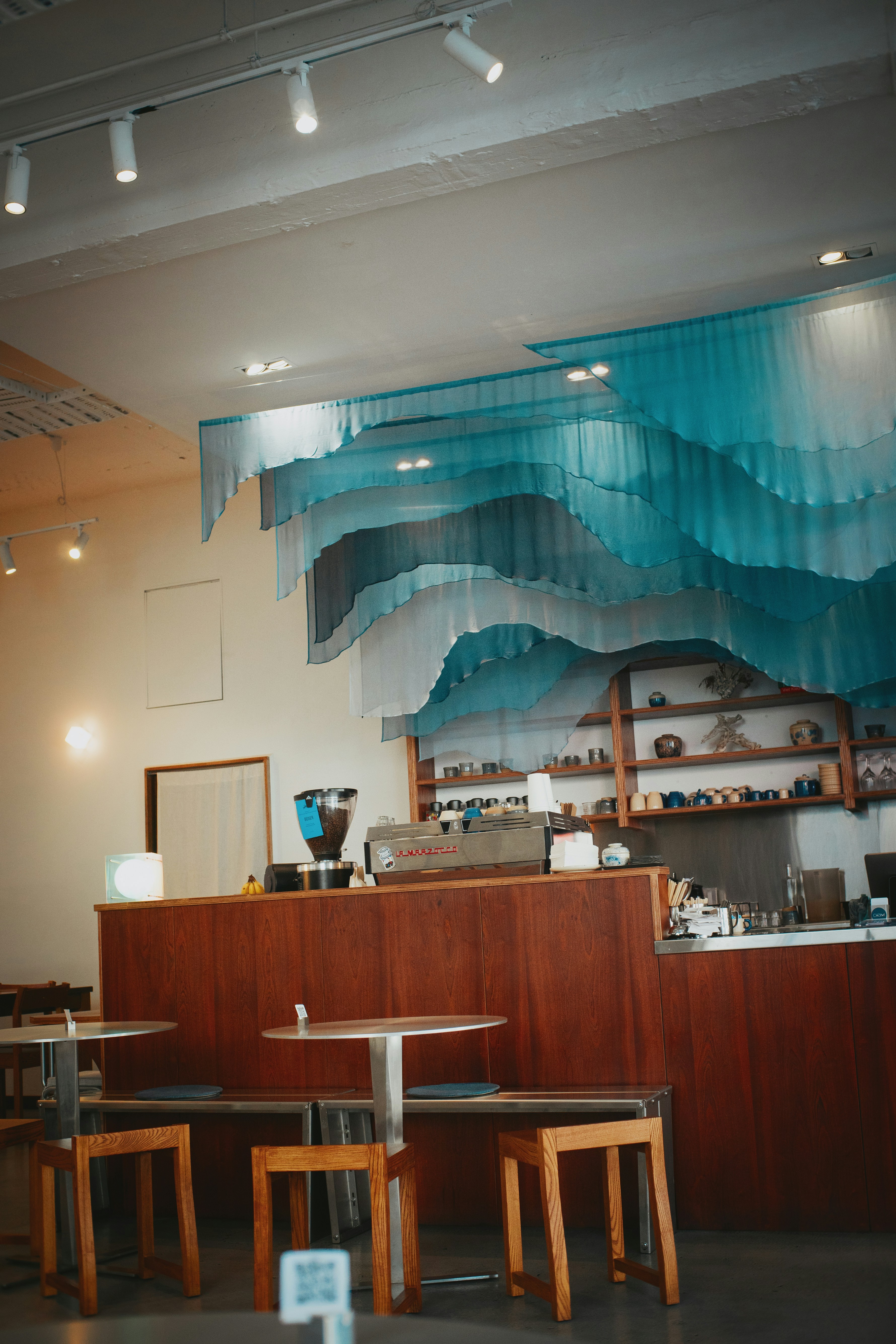 Blue Wave Ceiling Over a Quiet Café Counter
