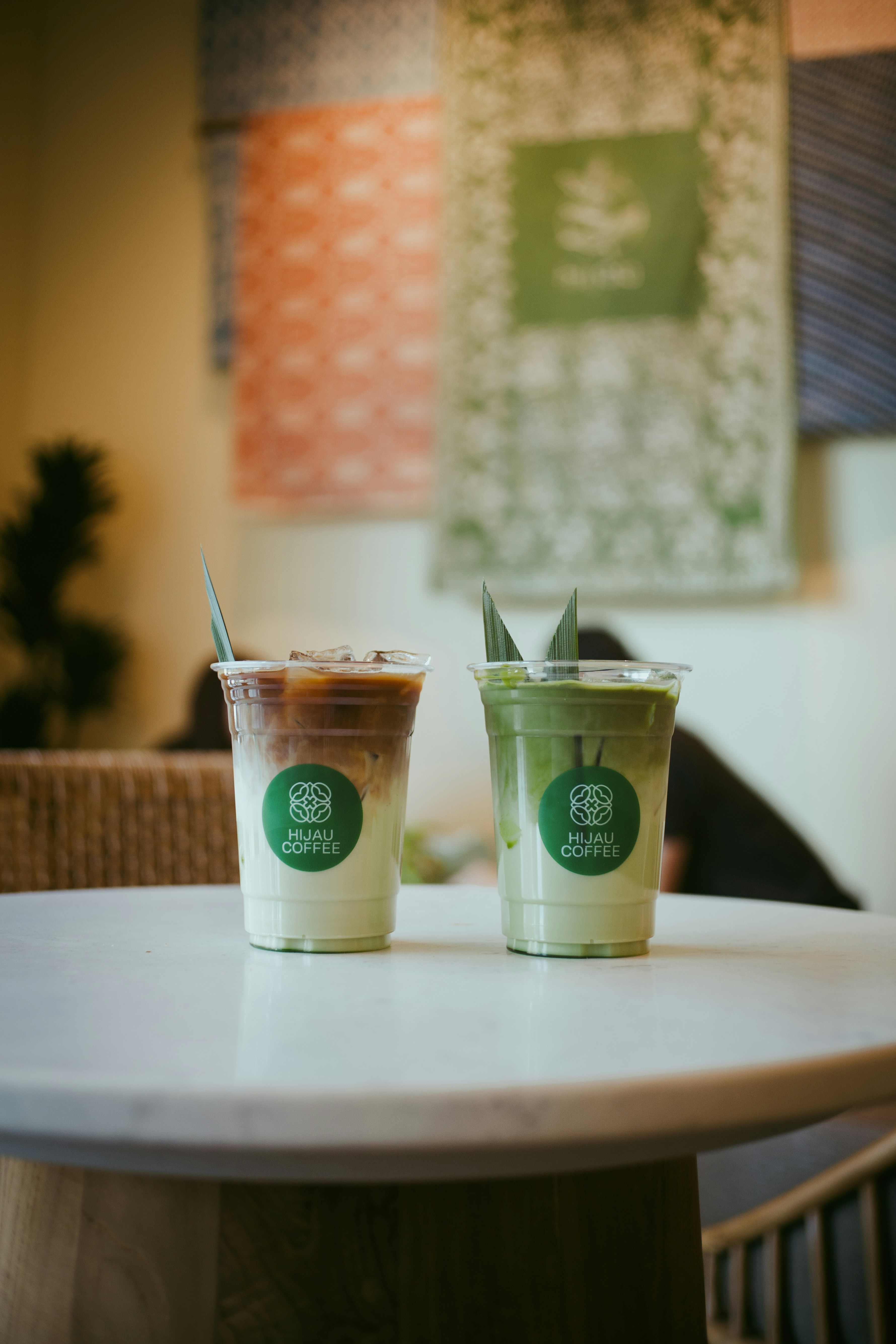 Twin Green and Cream Coffees on a Quiet Café Table