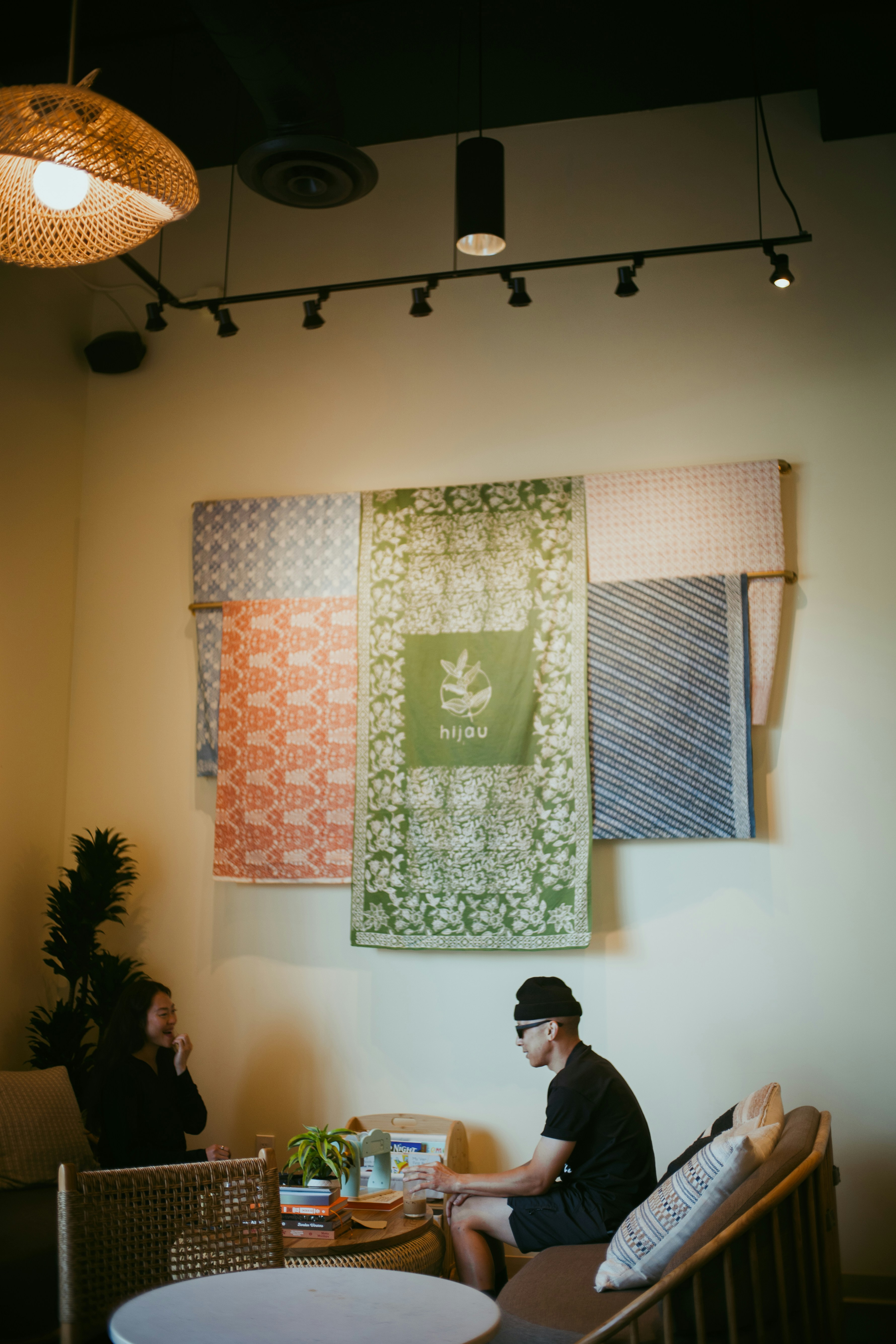 Quiet Conversation Under a Gallery of Fabrics