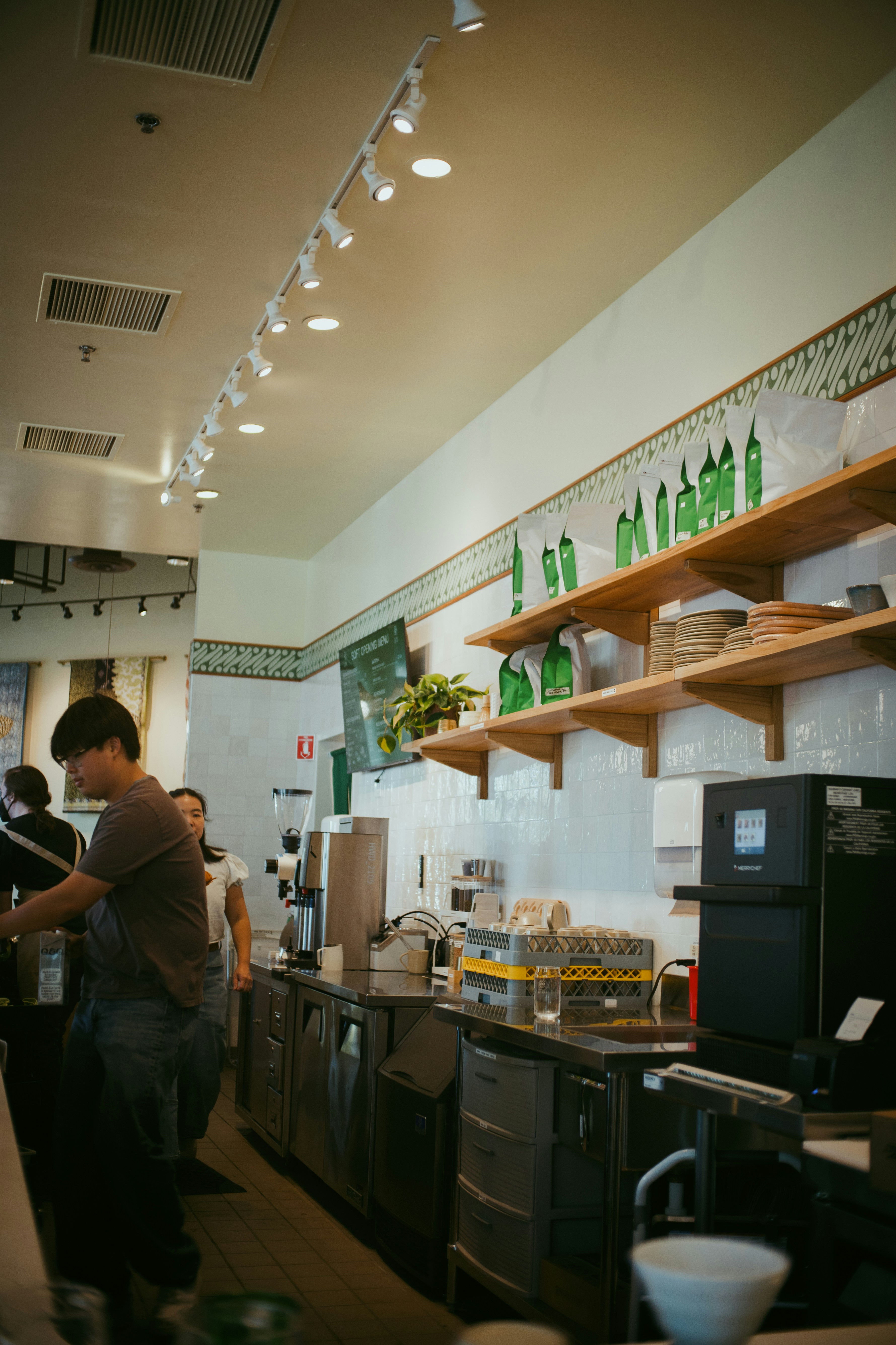 Cafe Portrait in Motion: Barista and patrons during a busy shift