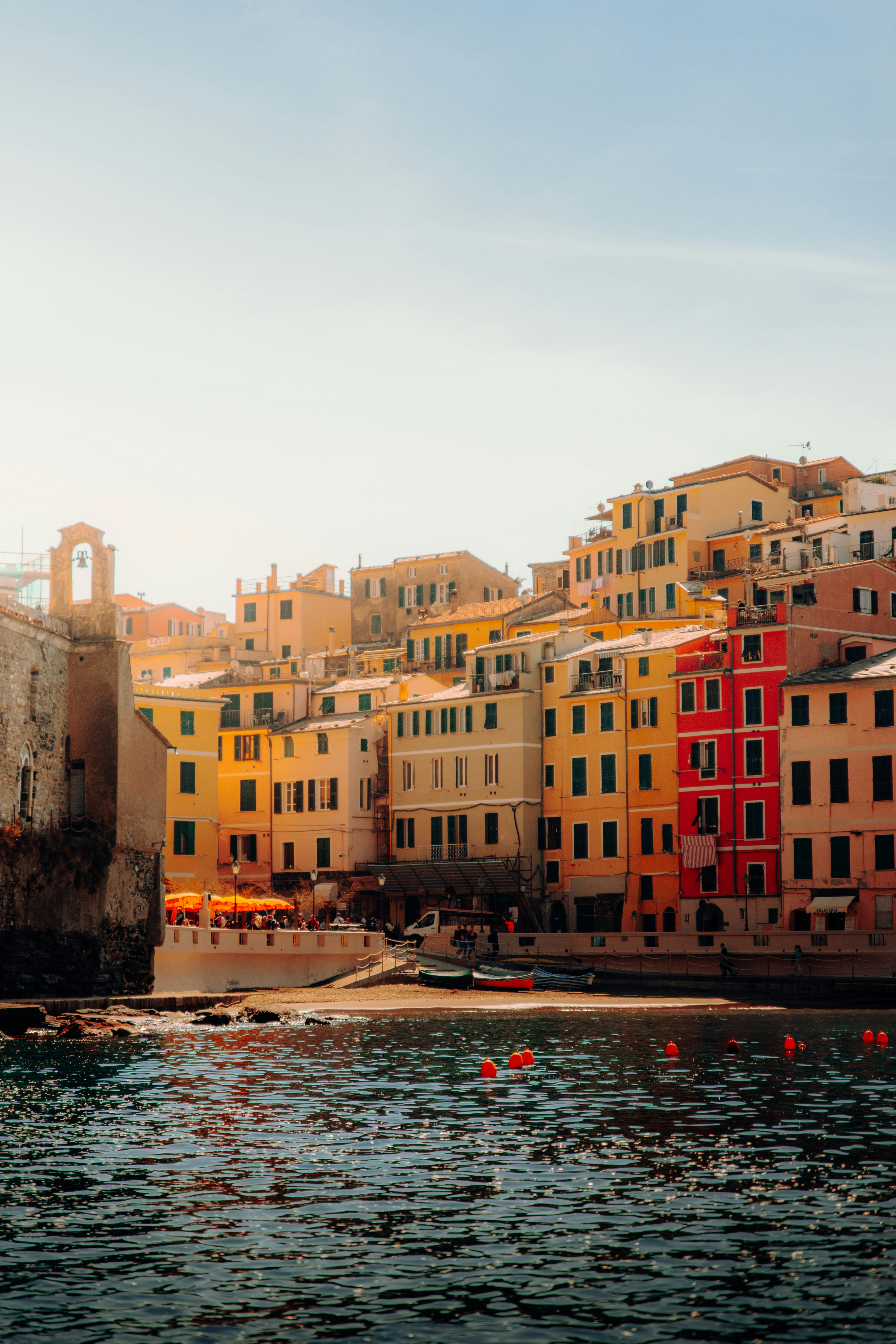 Sunlit Colonnade of Colorful Facades by the Harbor