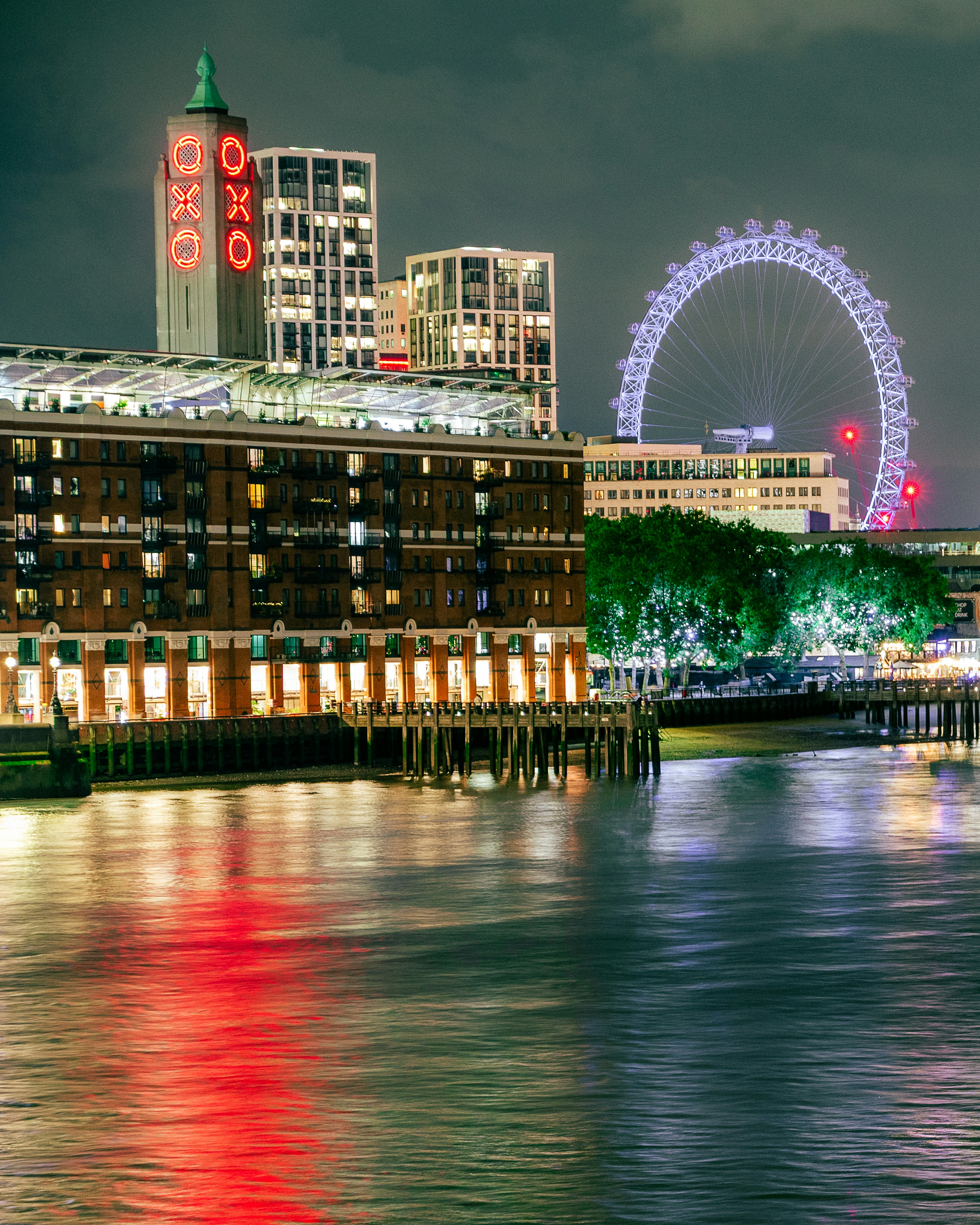 Bright Riverfront Afterglow with London-Style Clock Tower and the London Eye Silhouette