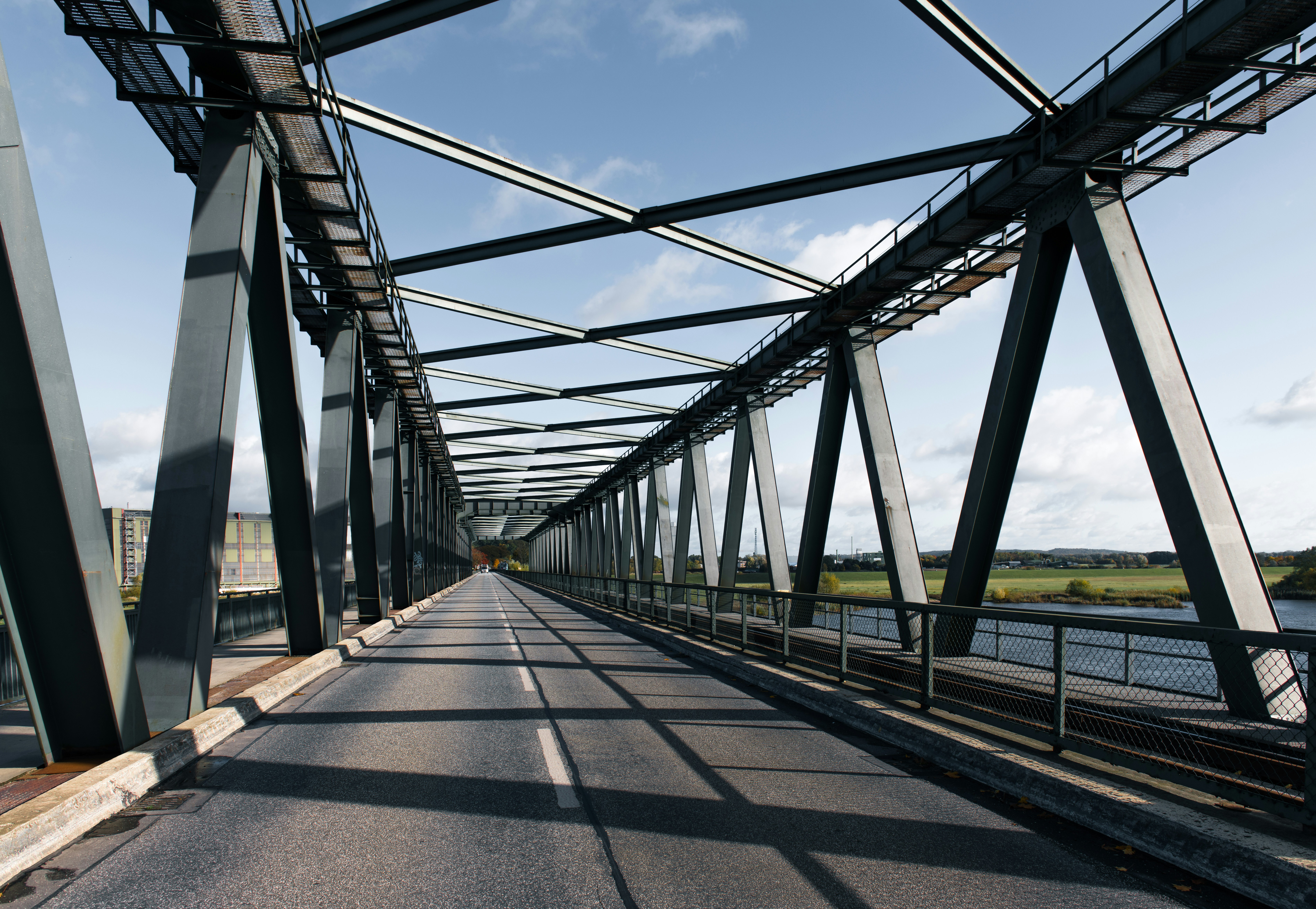 Sunlit Bridge Crossing: Geometric Rails Leading to the Horizon