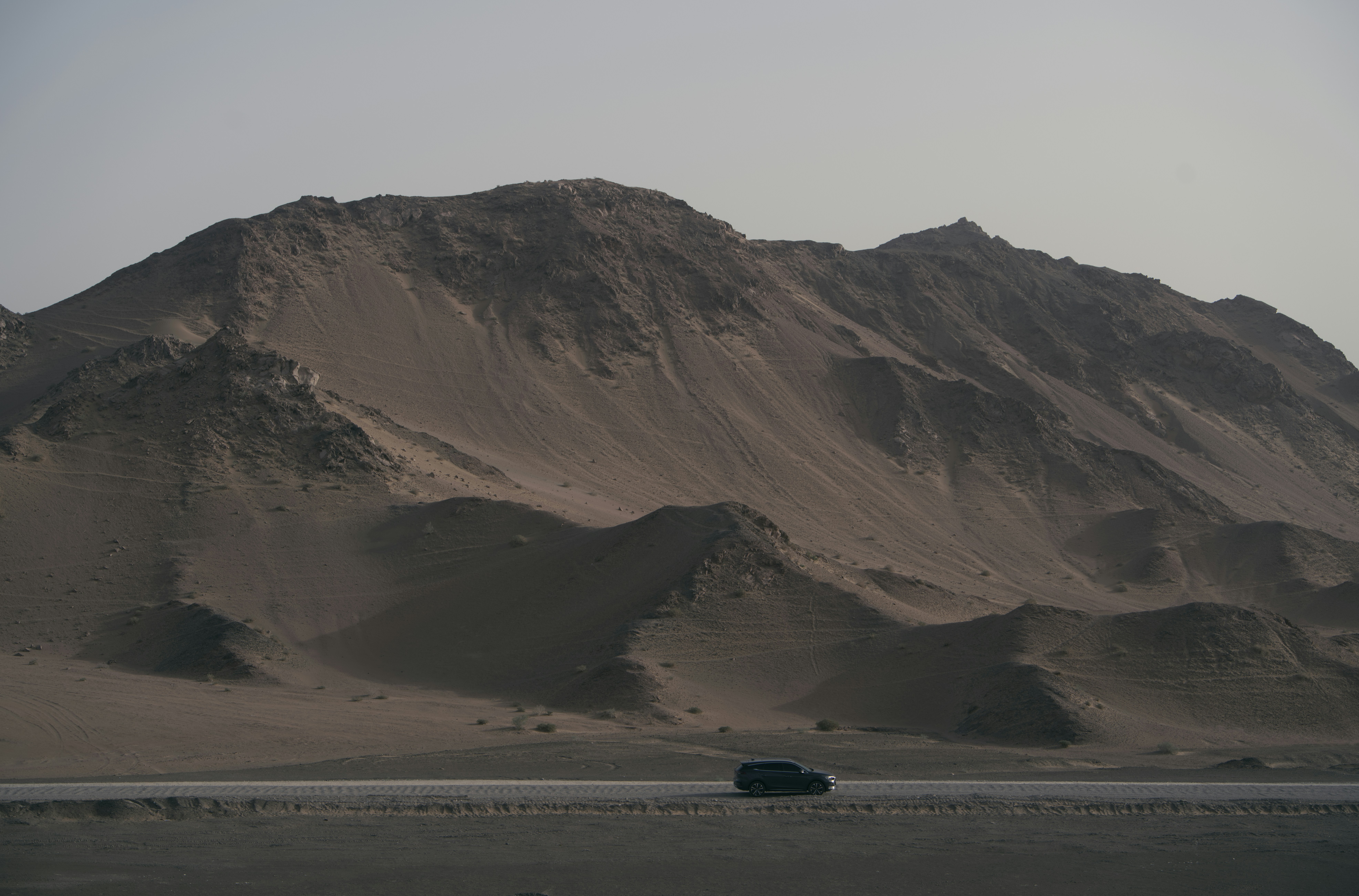 Desert Plateau with a lone Vehicle at the Base