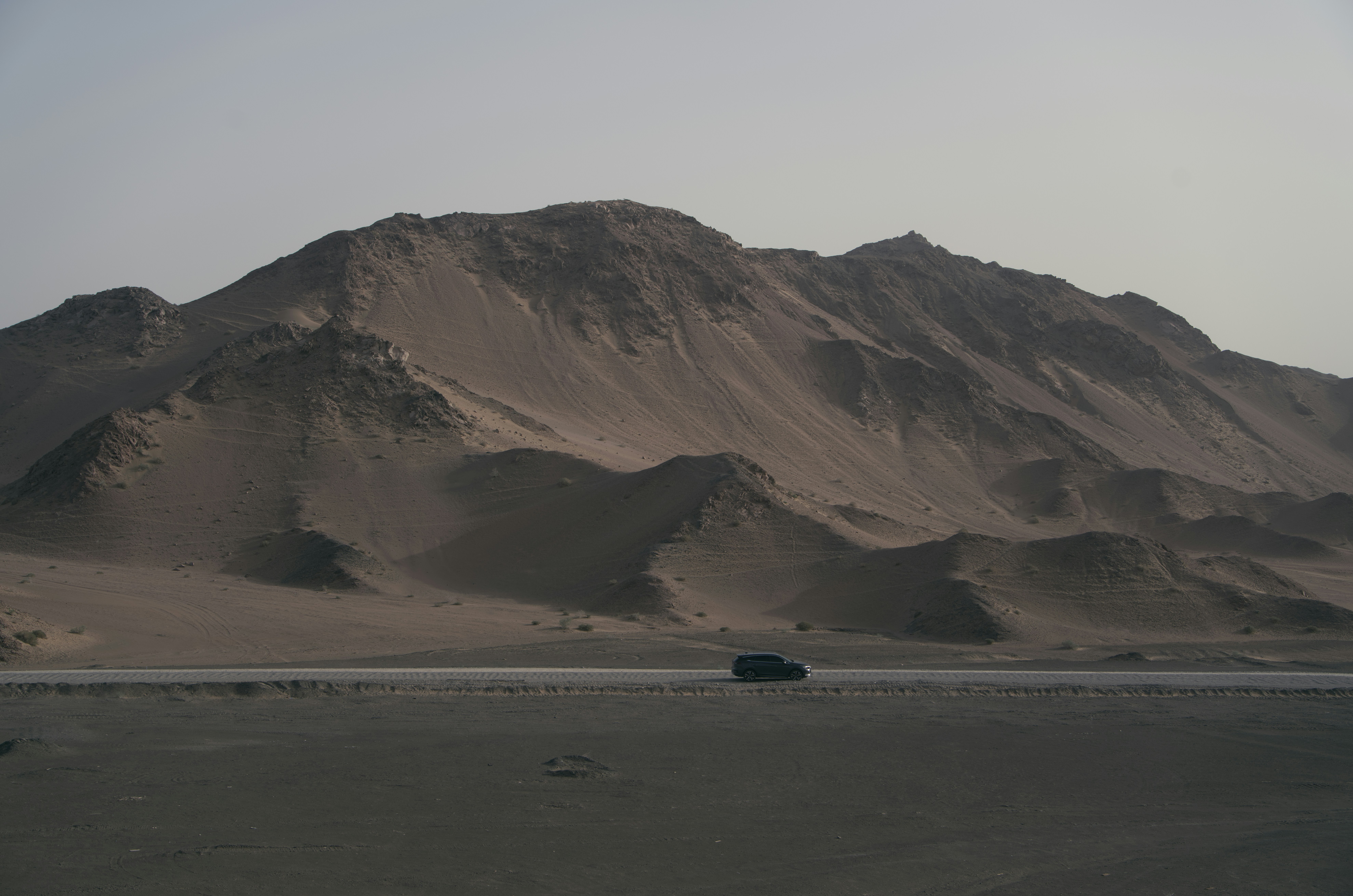 Lonely Vehicle at the Edge of a Desert Ridge