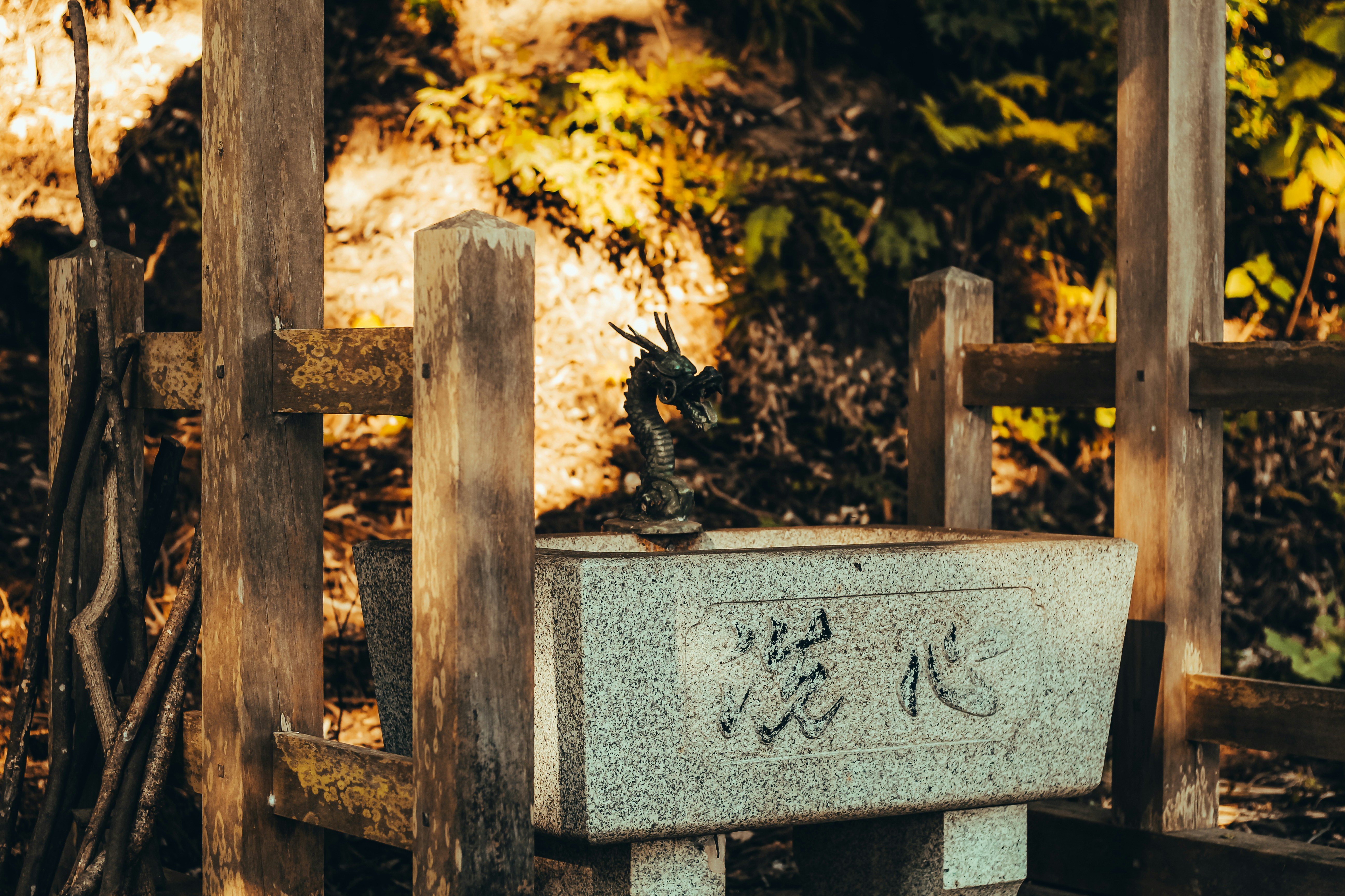 Stone Altar Framed by Weathered Posts in a Quiet Shrine