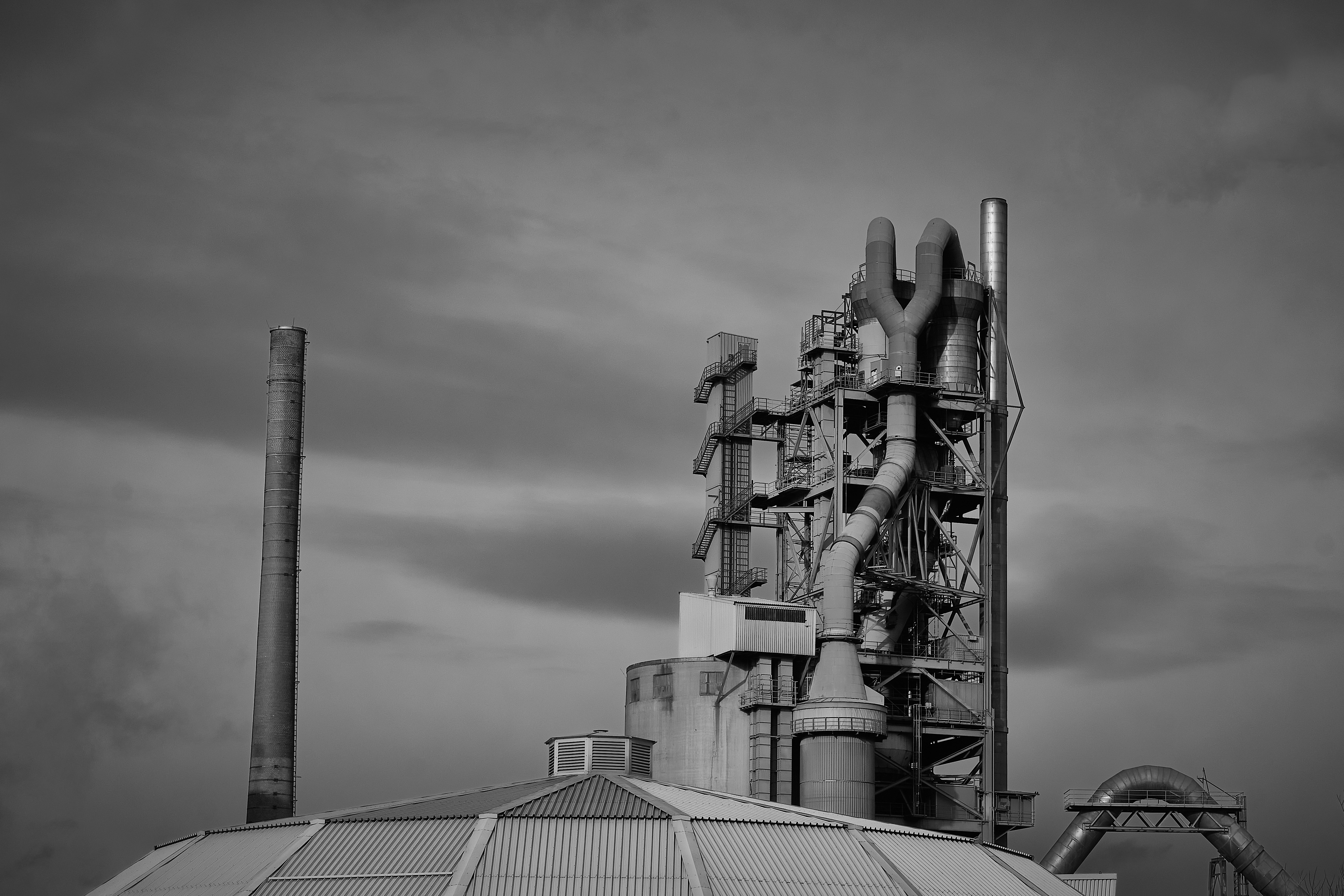 Industrial silhouette: The factory's vertical maze against a moody sky