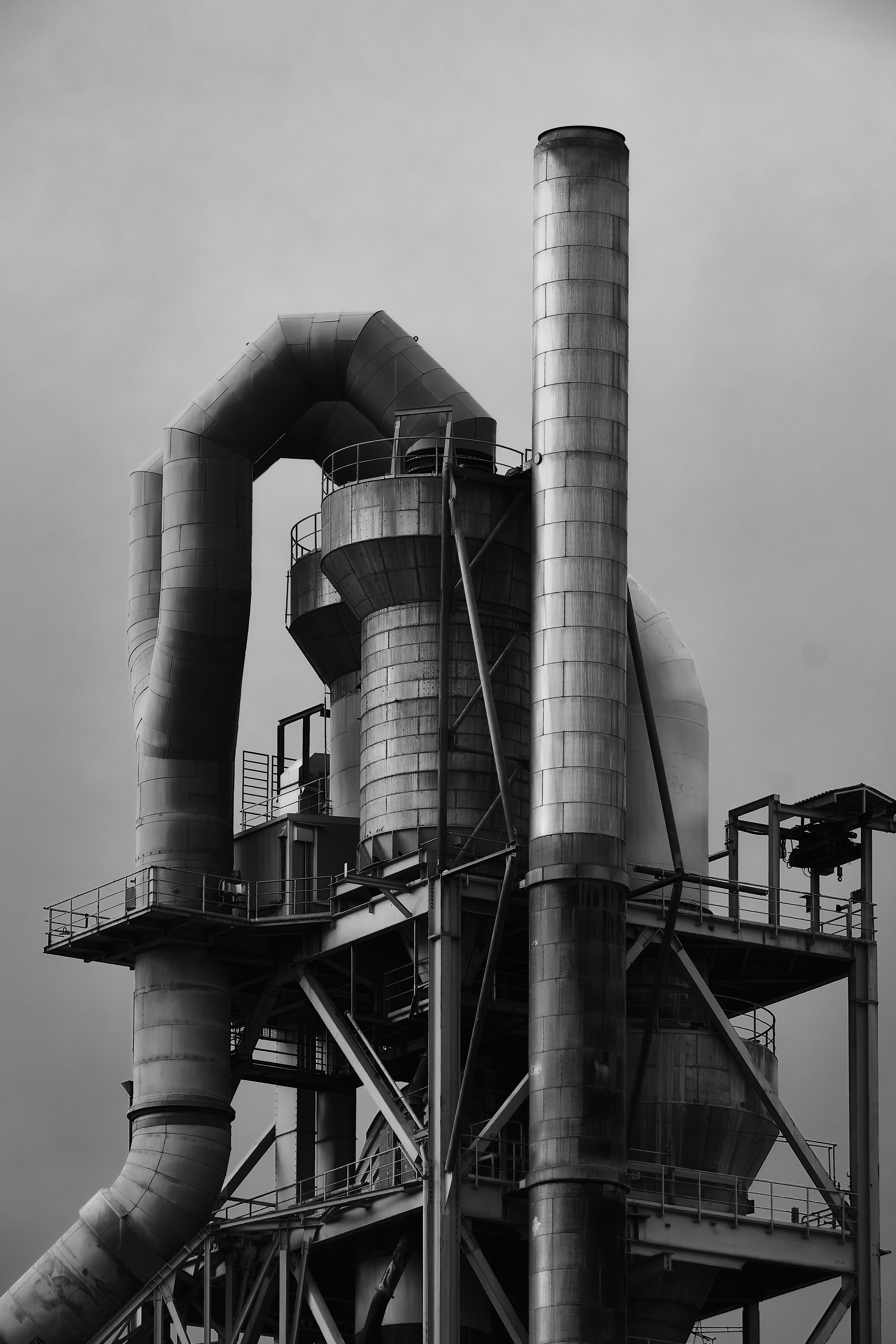Industrial Monolith: A Portrait of Steel Structures Against a Somber Sky