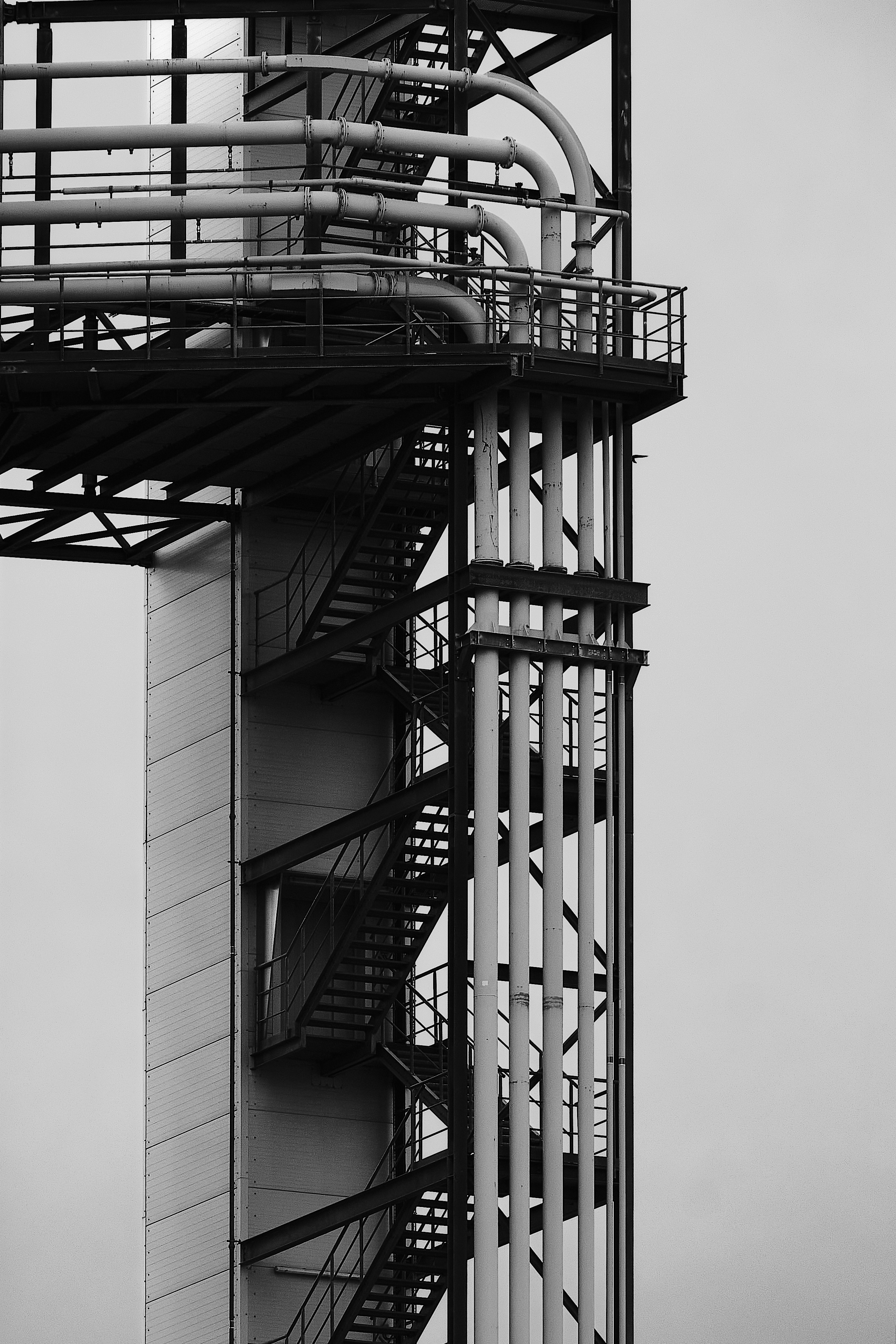 Industrial Geometry: A Monochrome Tower of Pipes and Stairs