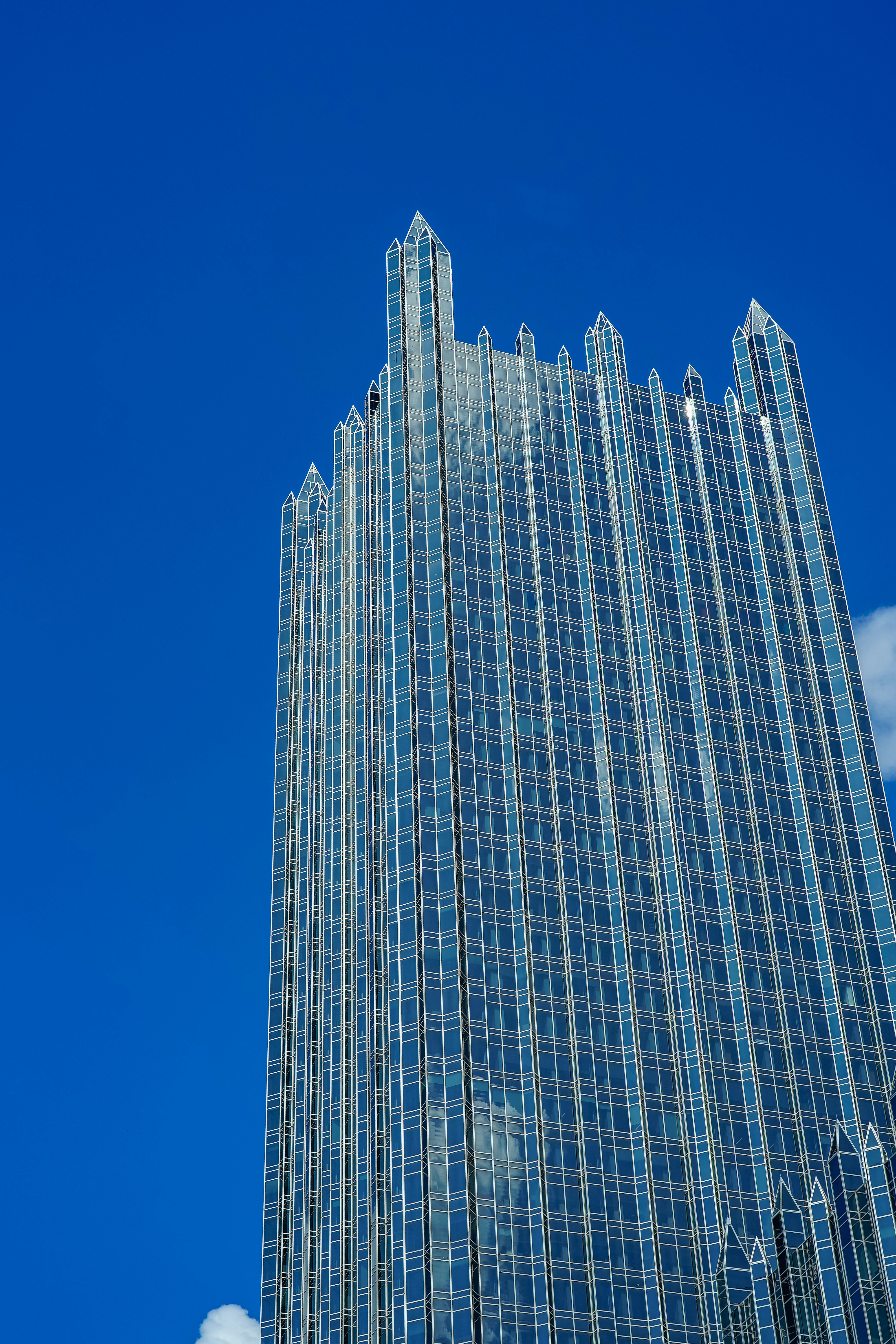 Skyward Facade: Glass Peaks Against a Cerulean Sky