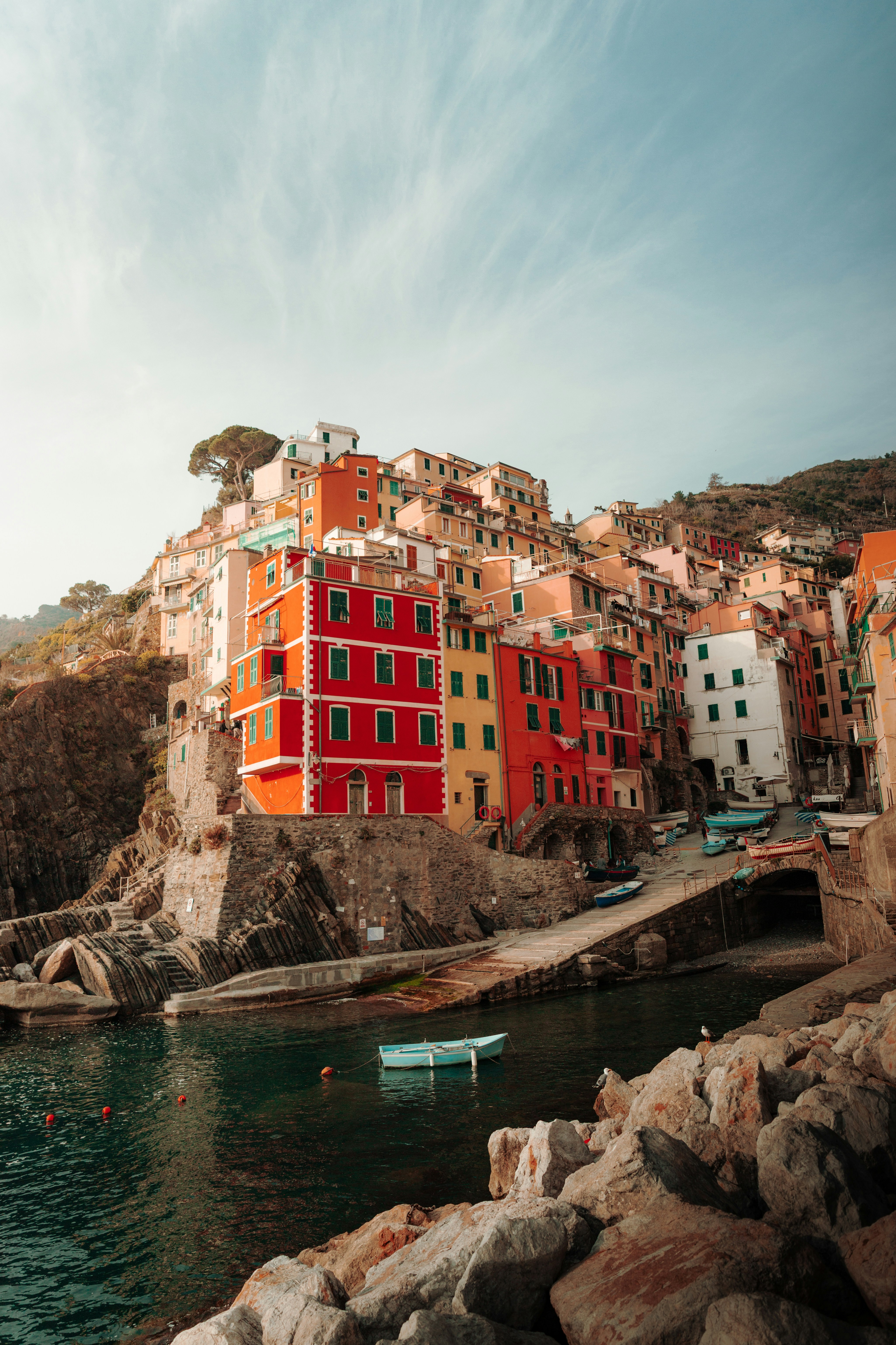 Vibrant hillside village clinging to the rocks by a turquoise cove