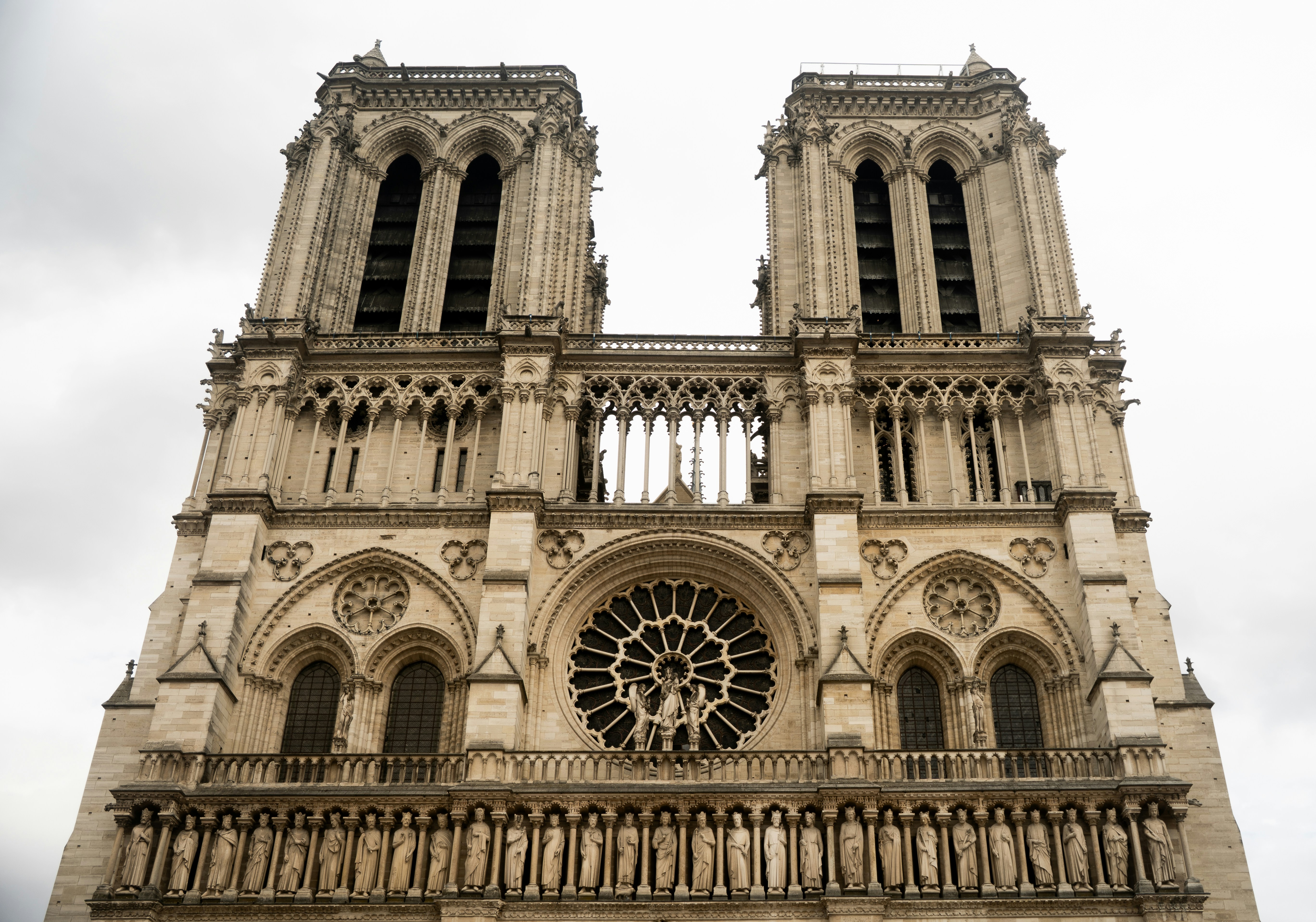 Notre-Dame Facade: Gilded Arches and Rose Window in Granite Symmetry