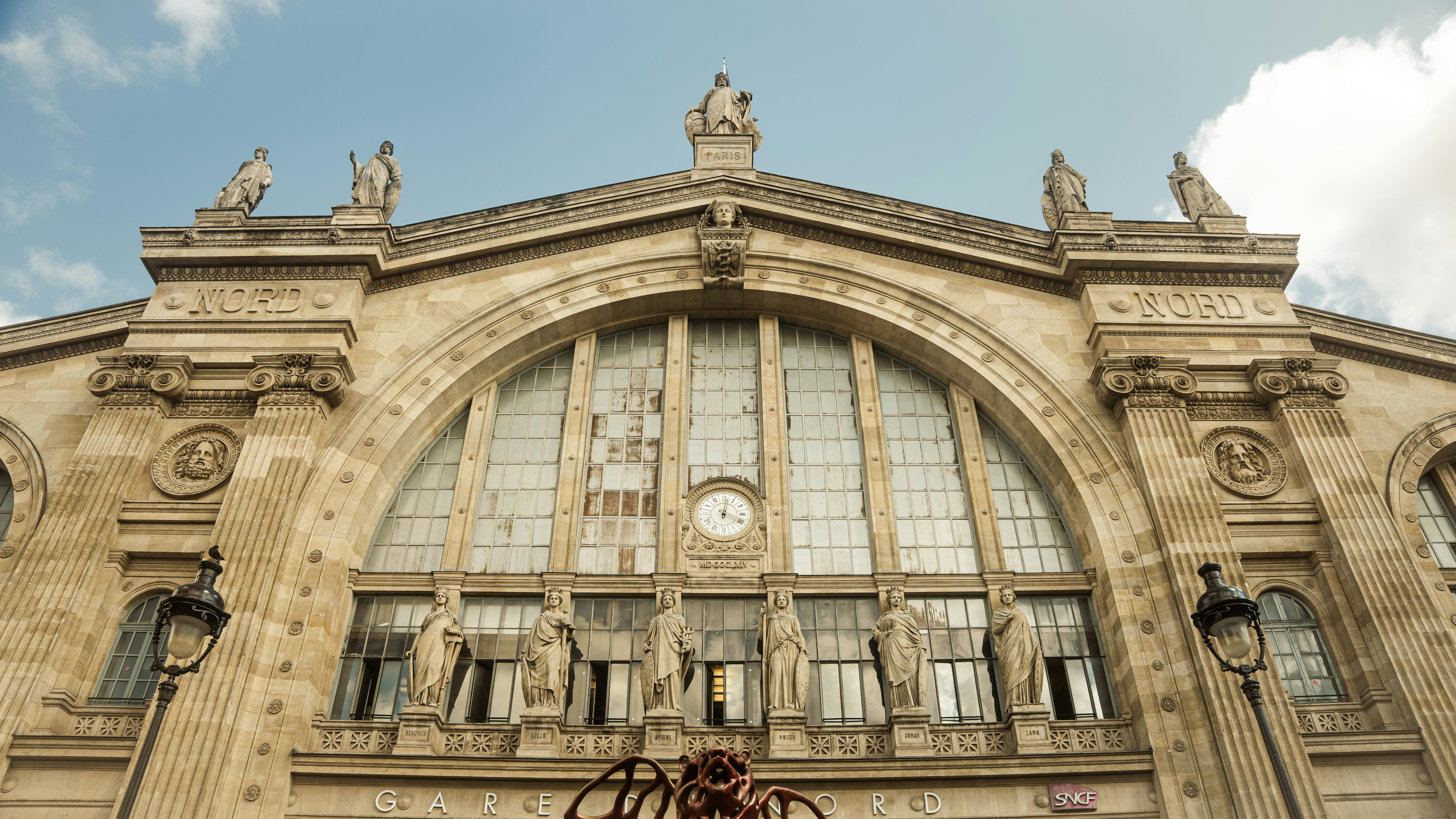 Architectural Symmetry: The Grand Station Facade with Sculpted Relics