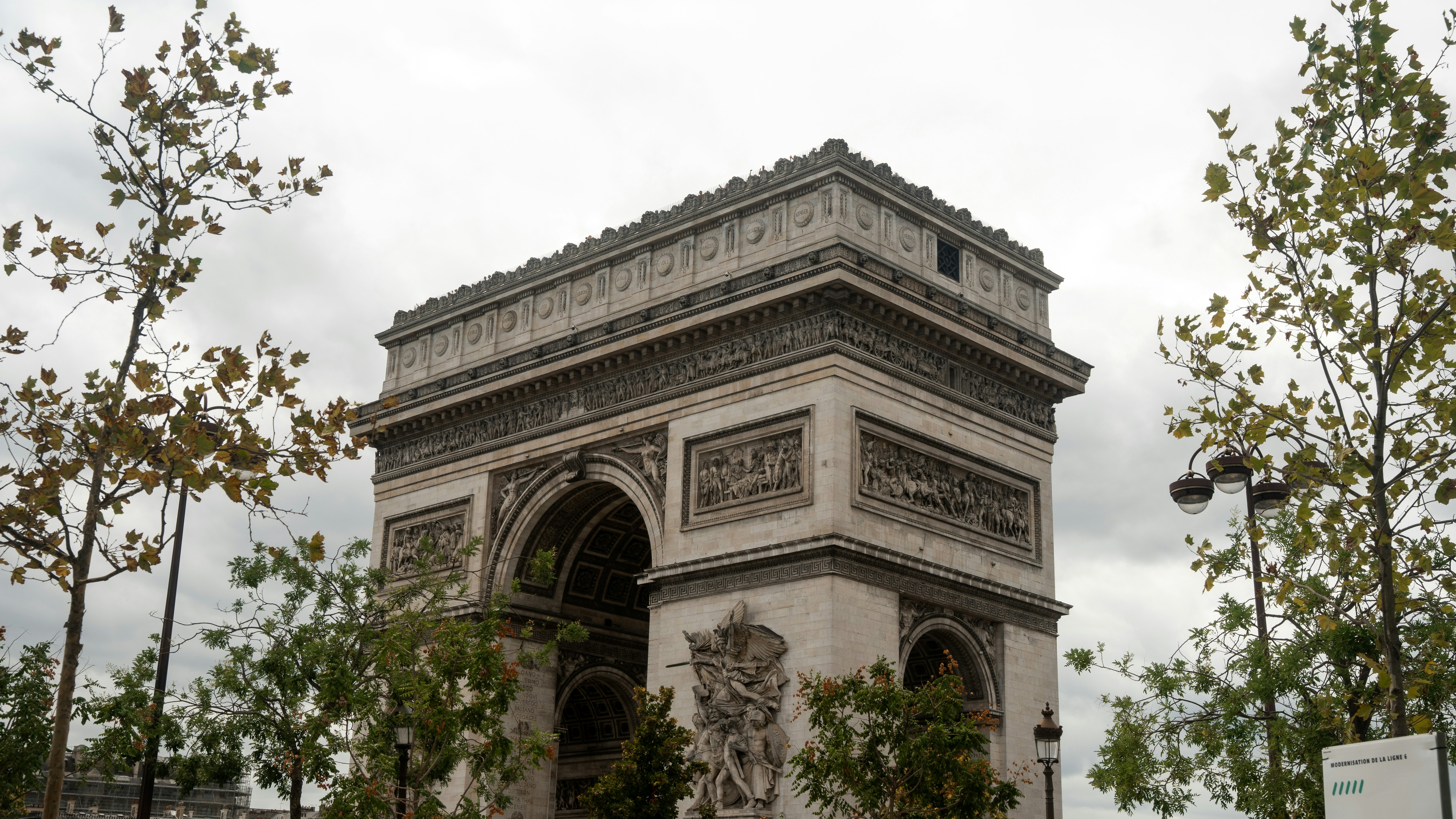 Arc of a Parisian Moment: Trees Framing the Monument