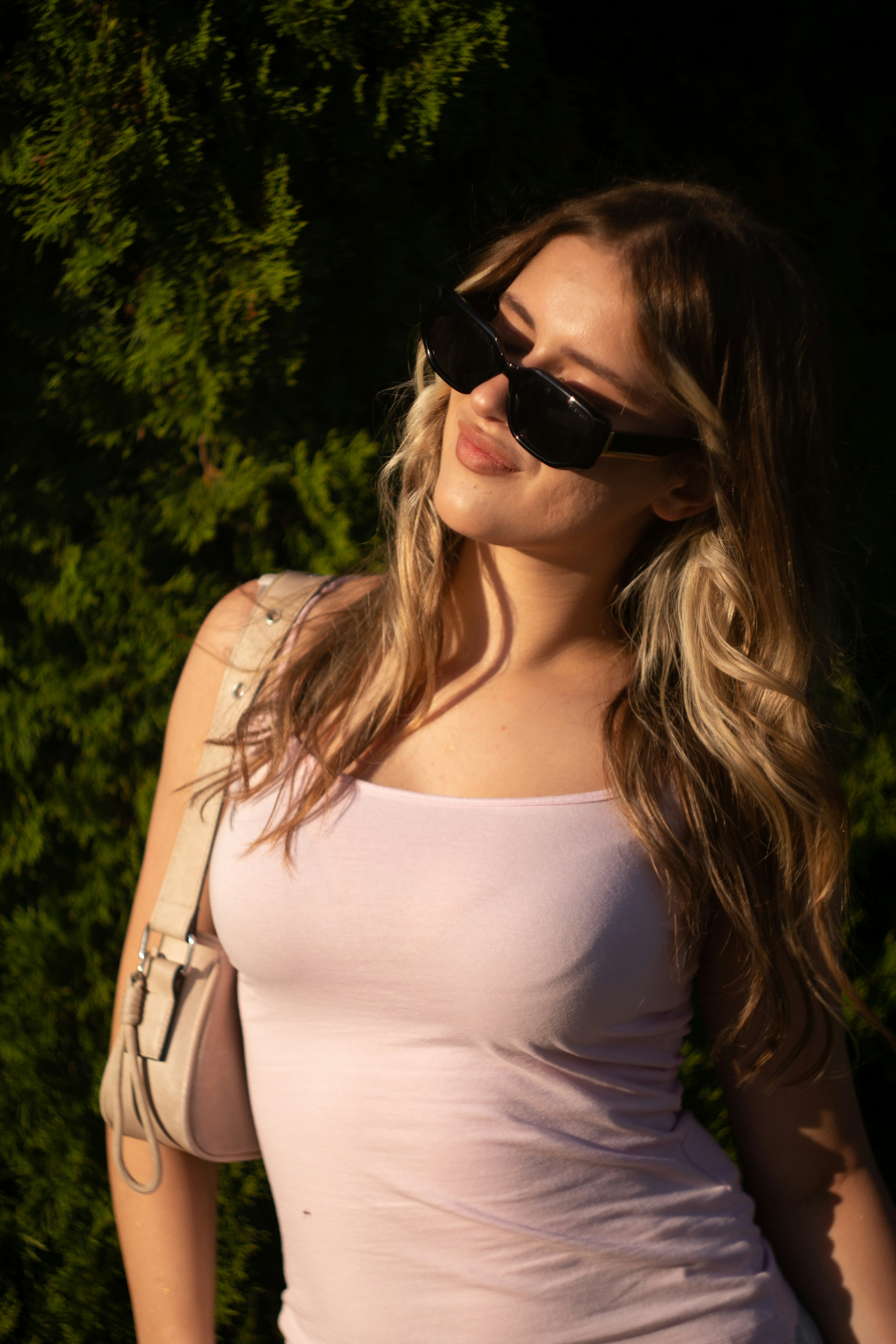 Sunlit Confidence: A Glimpse From Behind Sunglasses