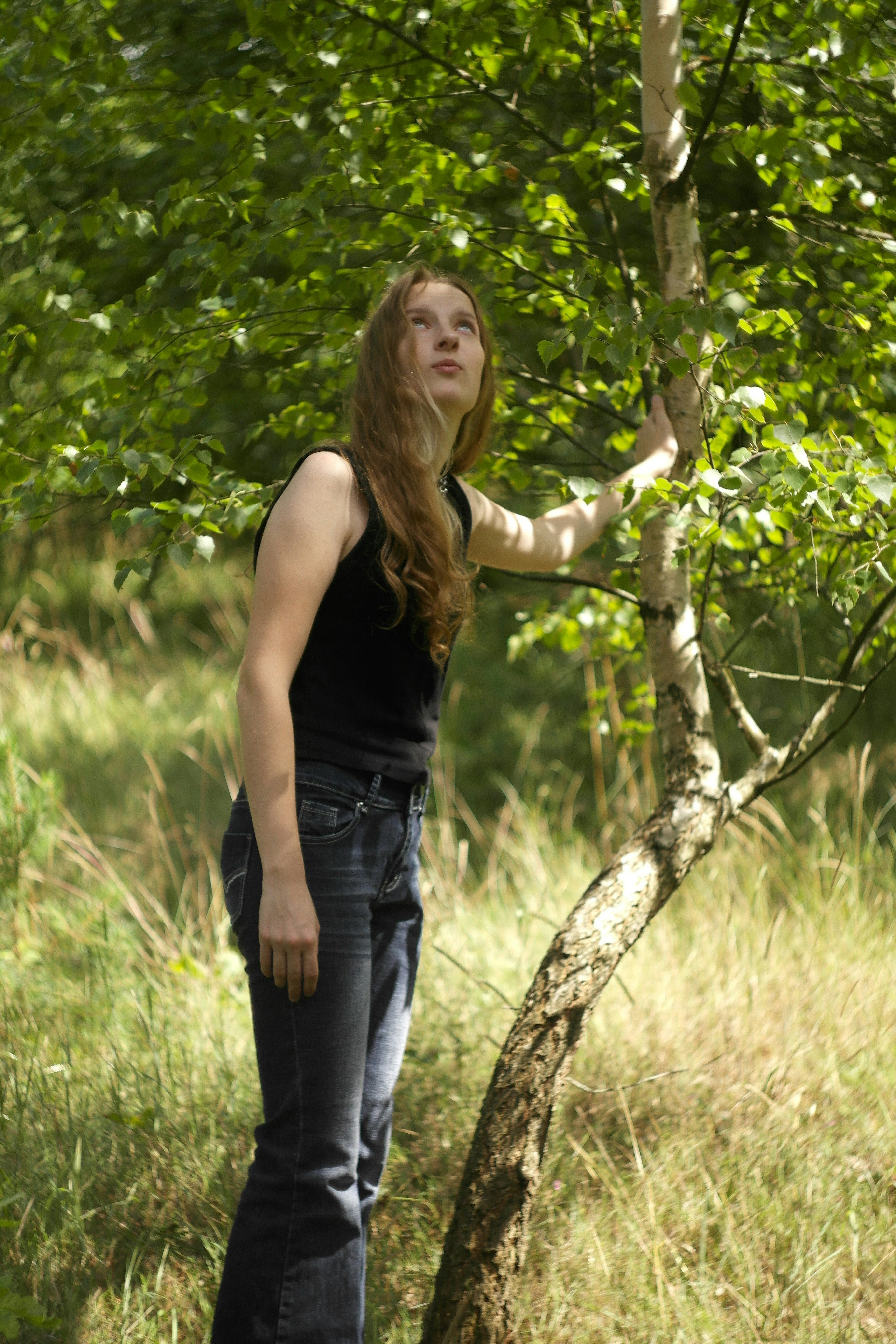 Girl in a Green Canopy Reaches Toward the Light