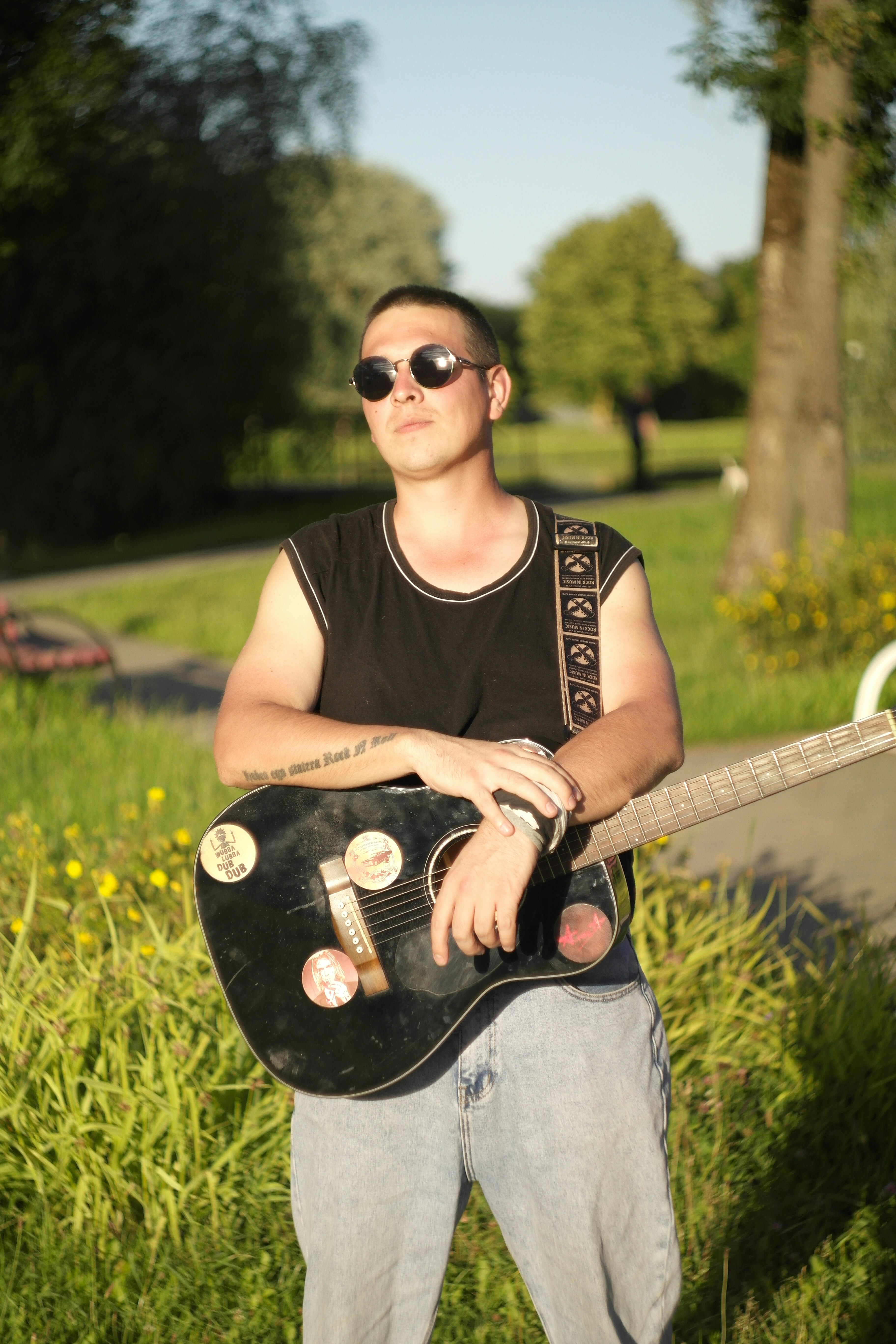 Guitarist in Sunlit Park Struts with a Shaded Soul