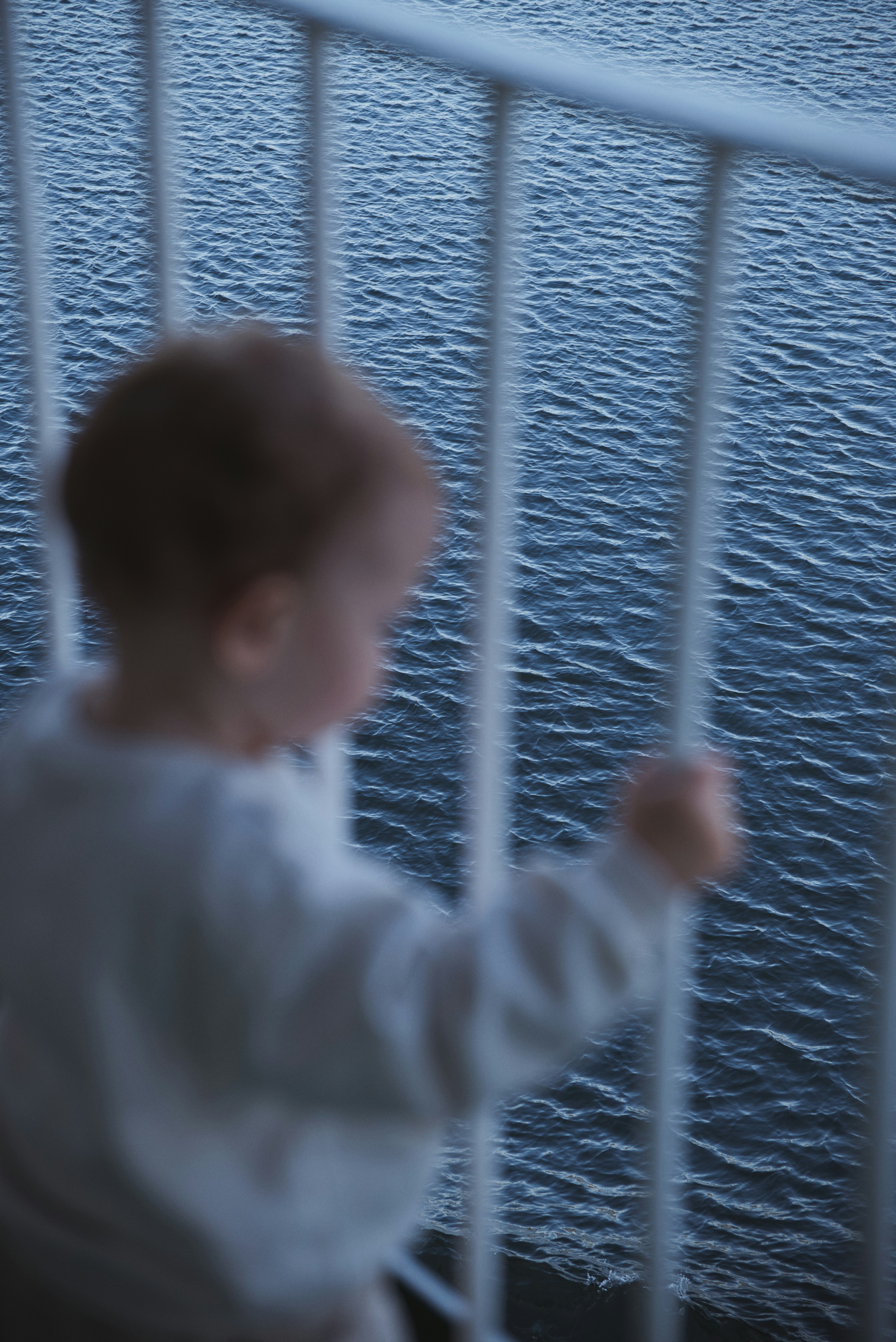Blurred Steps: A Moment at the Railing