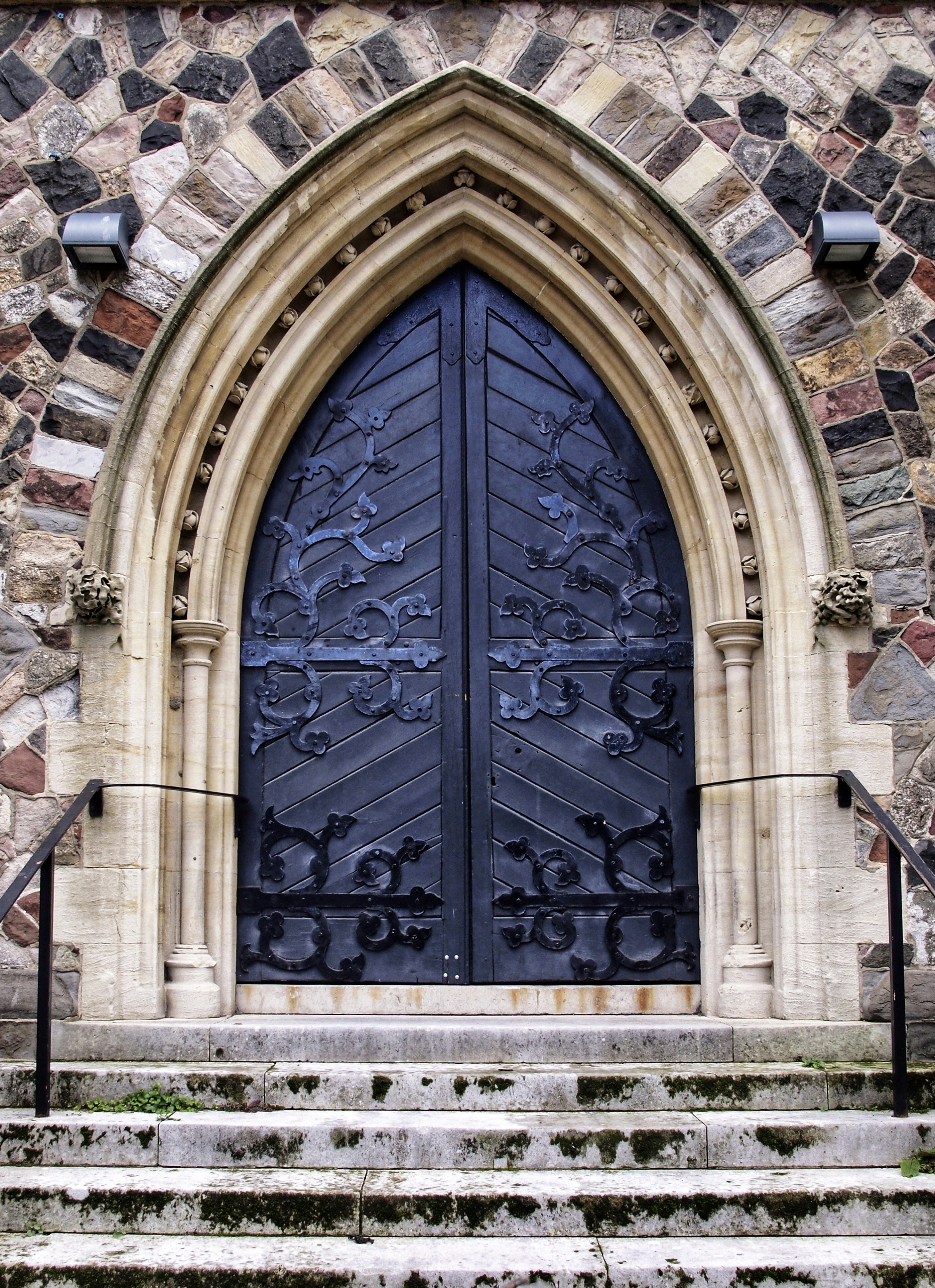 Arched Doorway in Weathered Stone: Gothic Stonework at Dusk