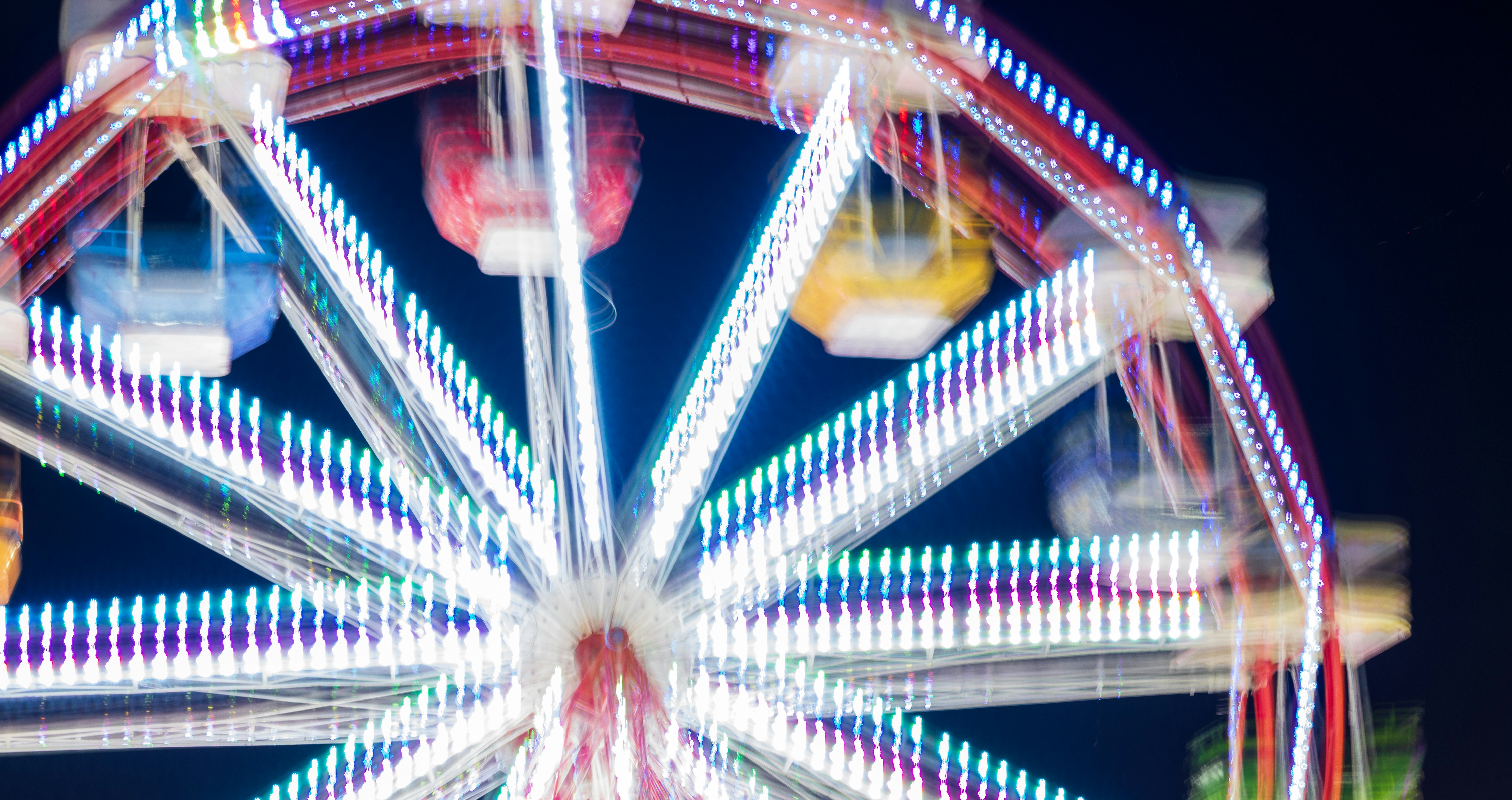 Lights in Motion: A Neon Ferris Wheel Blur