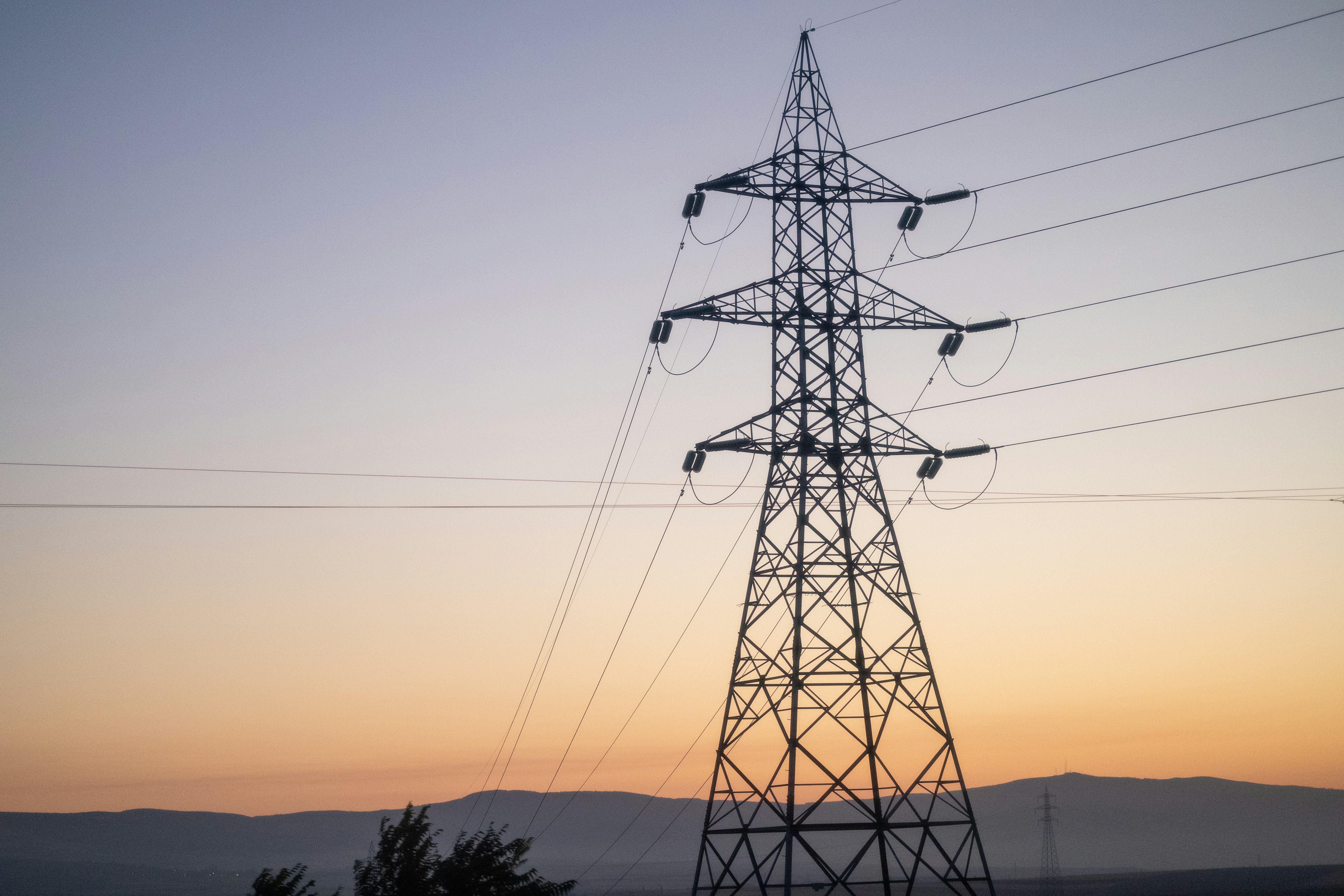 Silhouette of a Transmission Tower at Sunset
