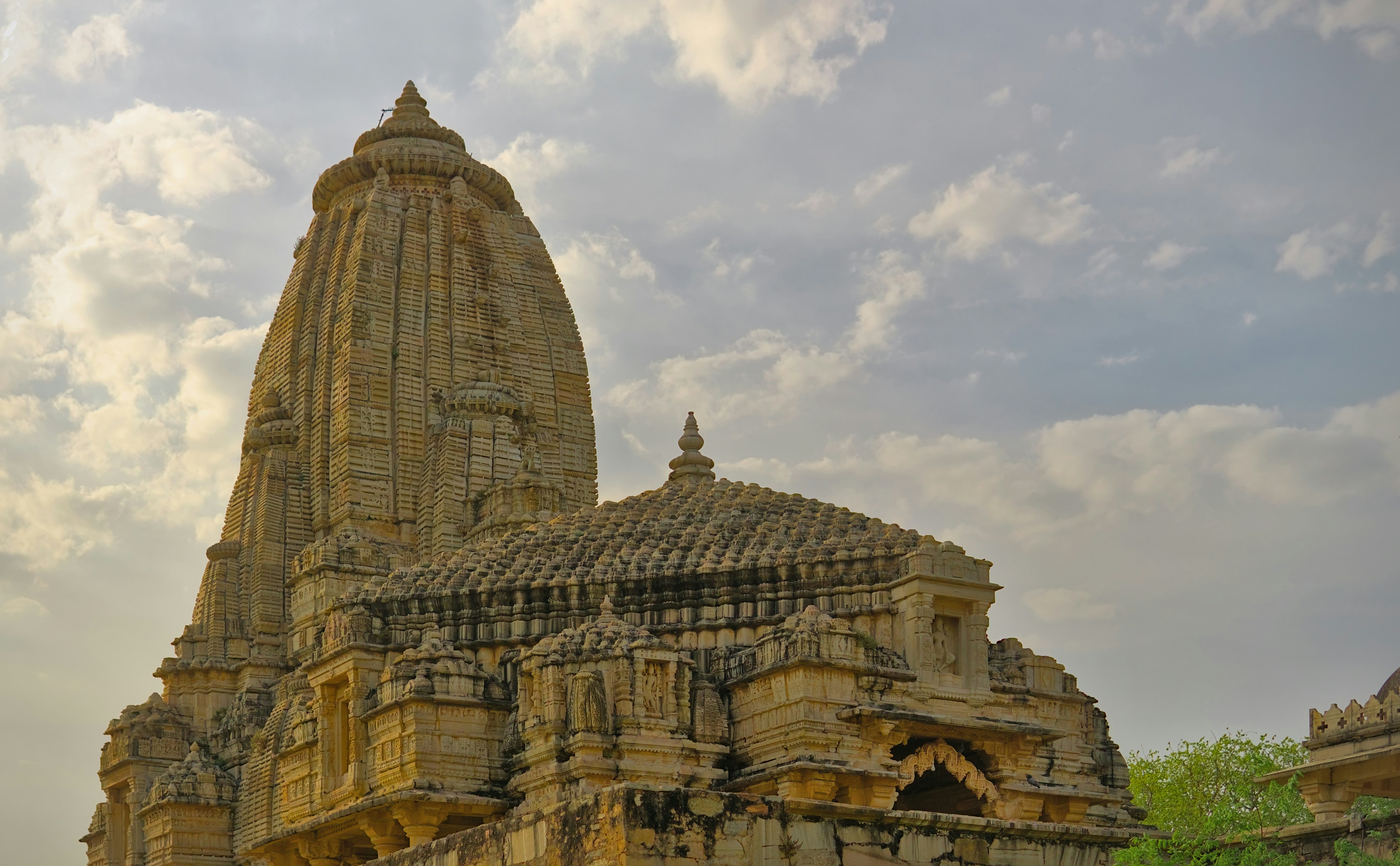 Sunlit ancient temple silhouette against a scarlet sky