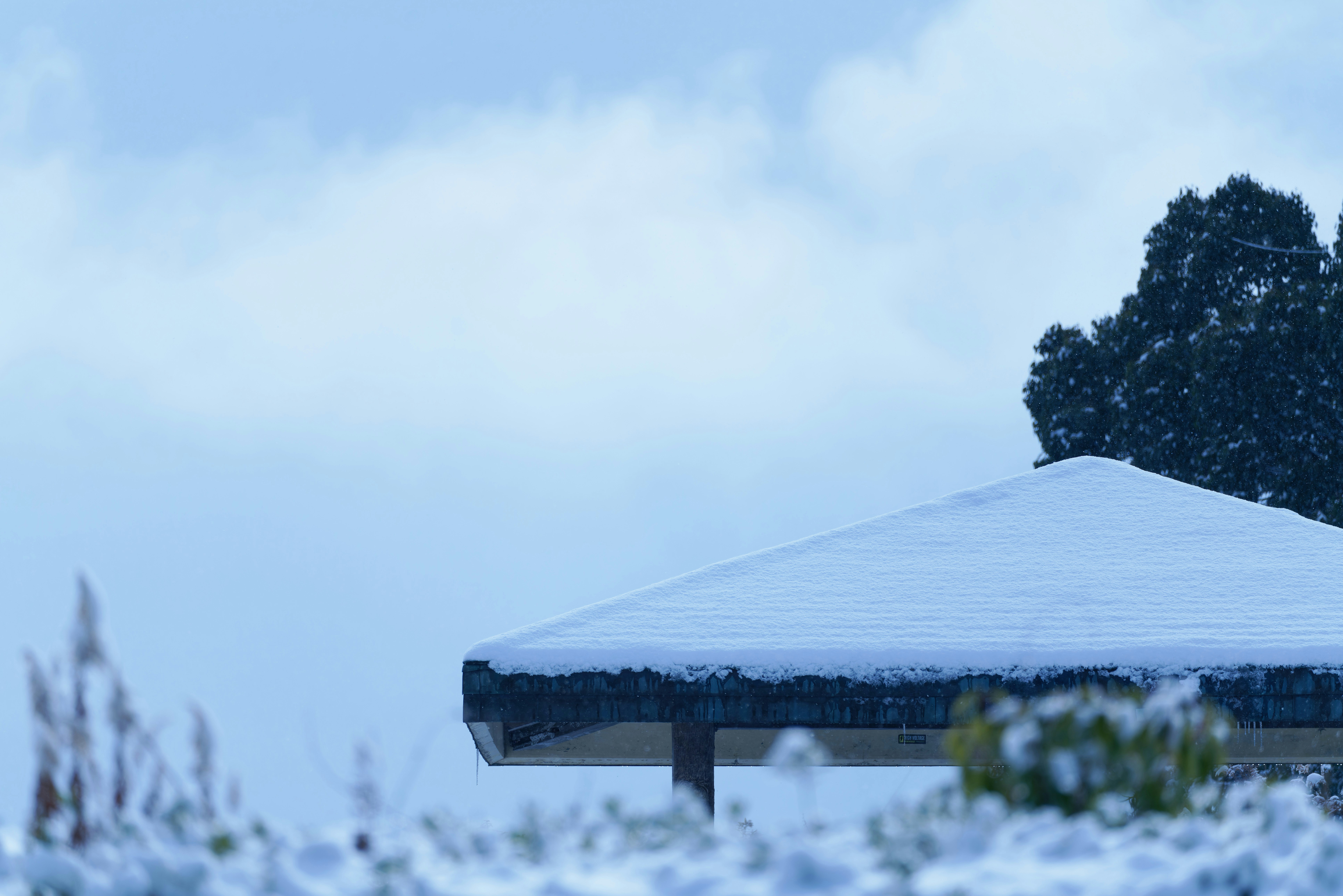 Snow-Covered Pavilion Under a Quiet Winter Sky