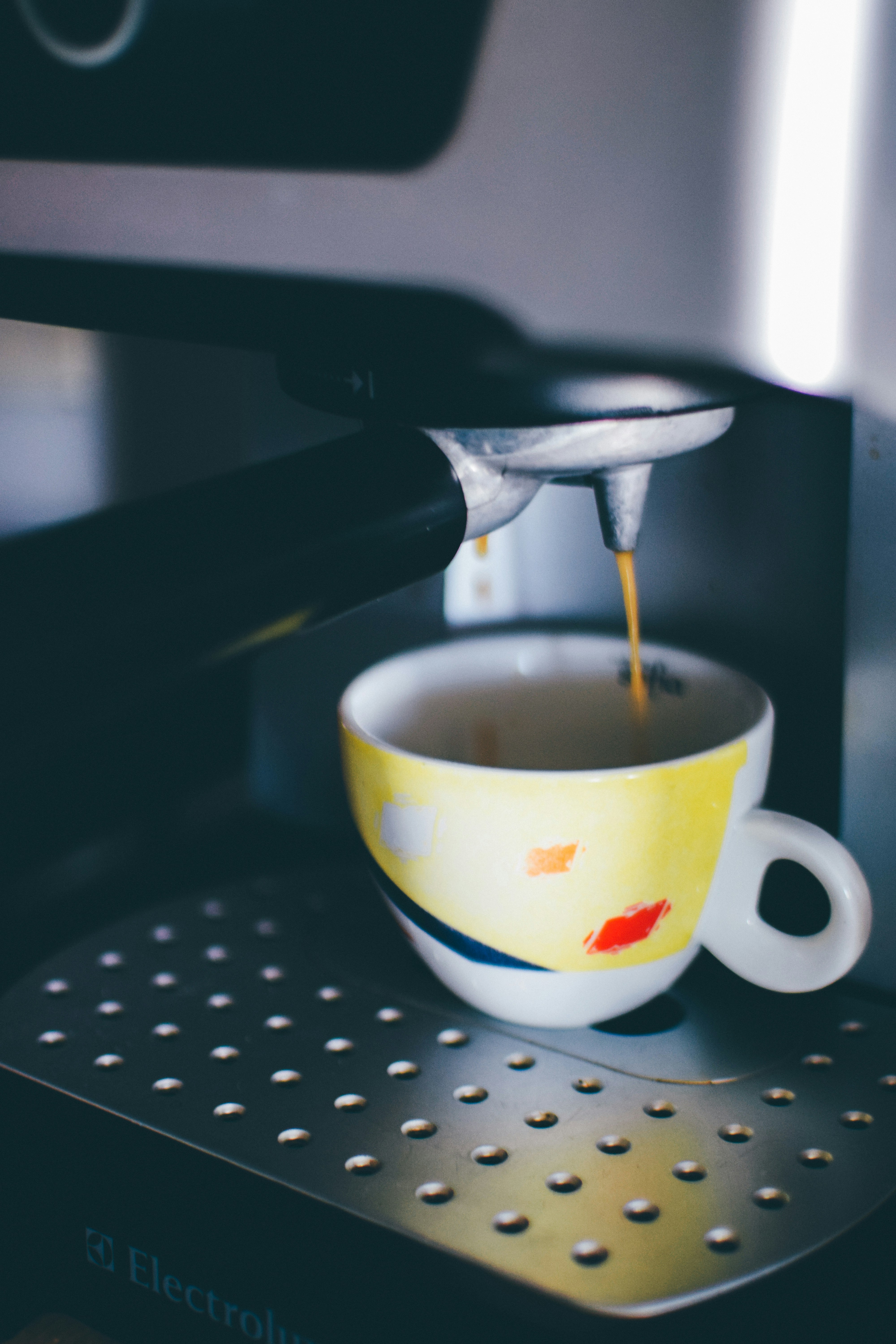 Warm Shot of a Coffee Ritual Under a Home Espresso Machine