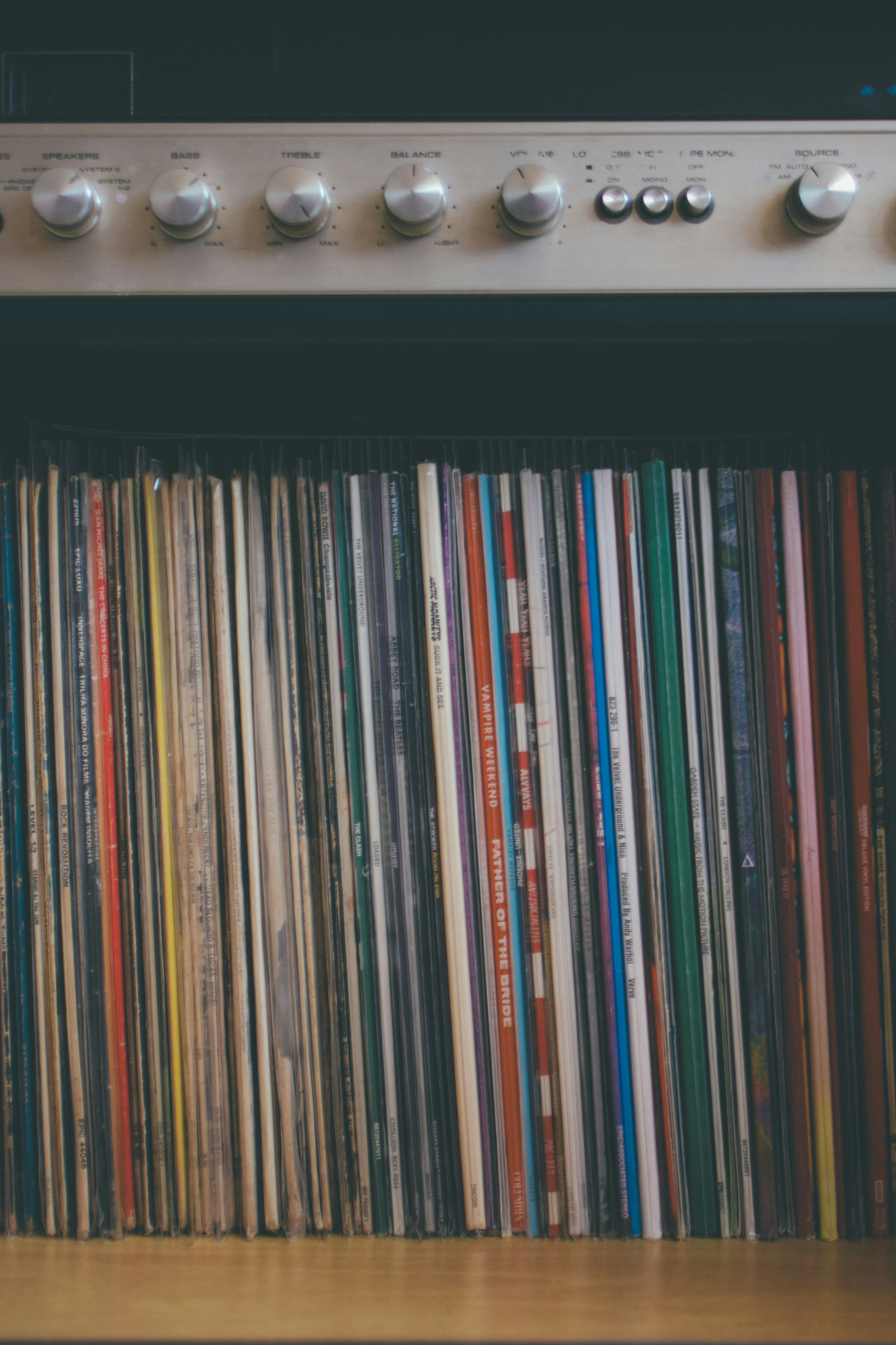 Vinyl Shelf Echo: A Vintage Receiver Overlooking a Sea of Records