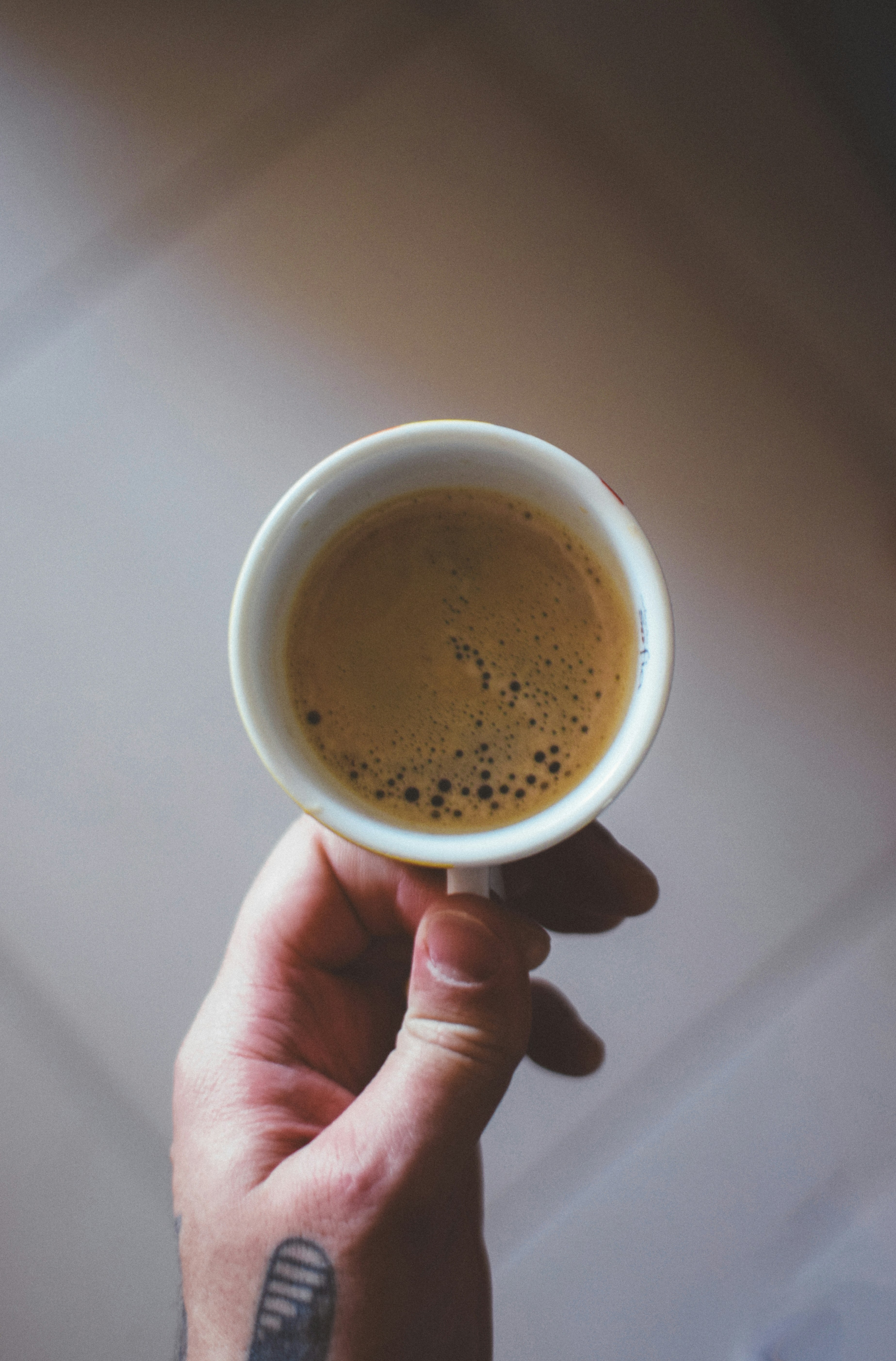 Handheld Coffee: A Top-Down Portrait of a Cup in Focus