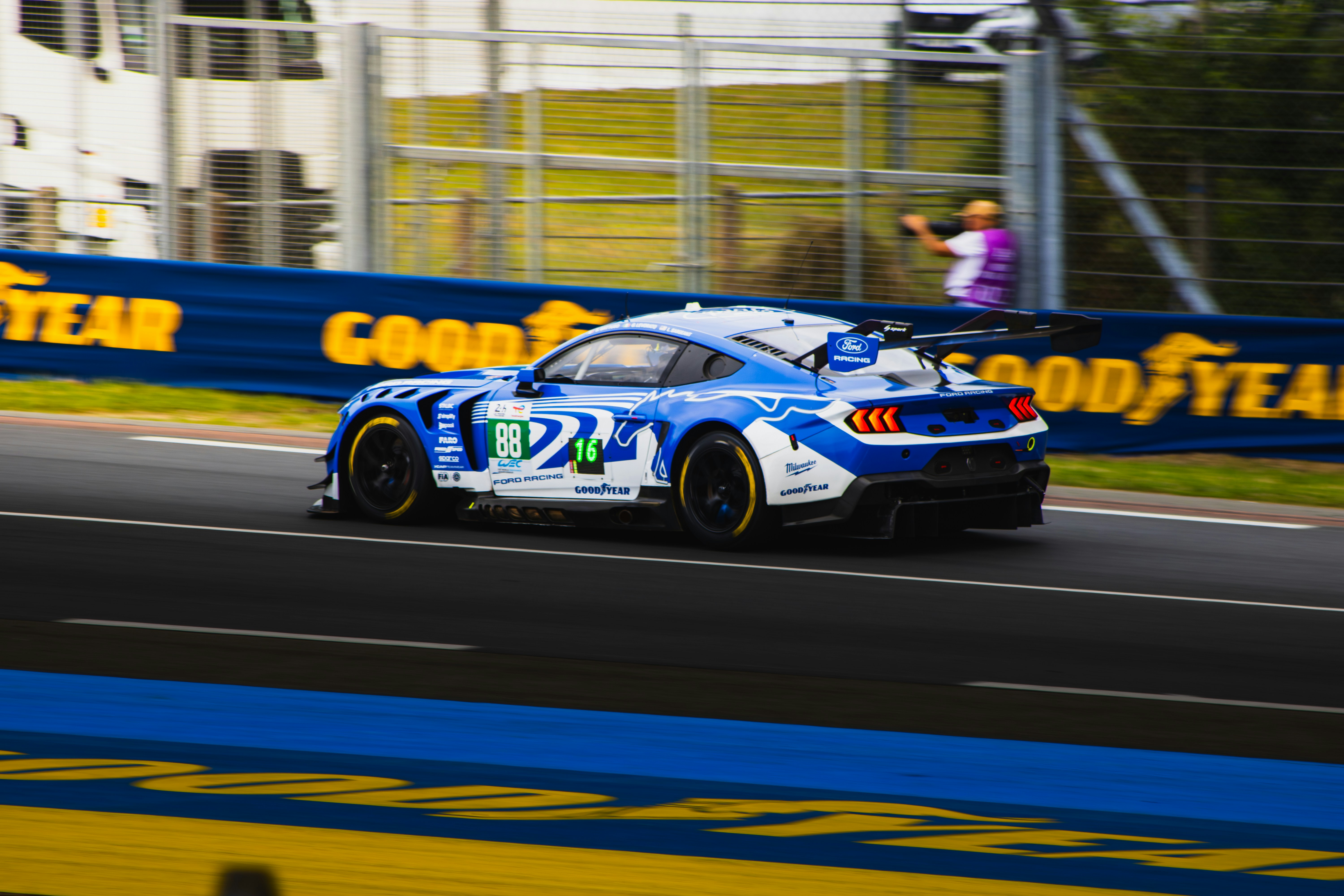 Blue-and-white GT Race Car in Full Throttle on a Circuit