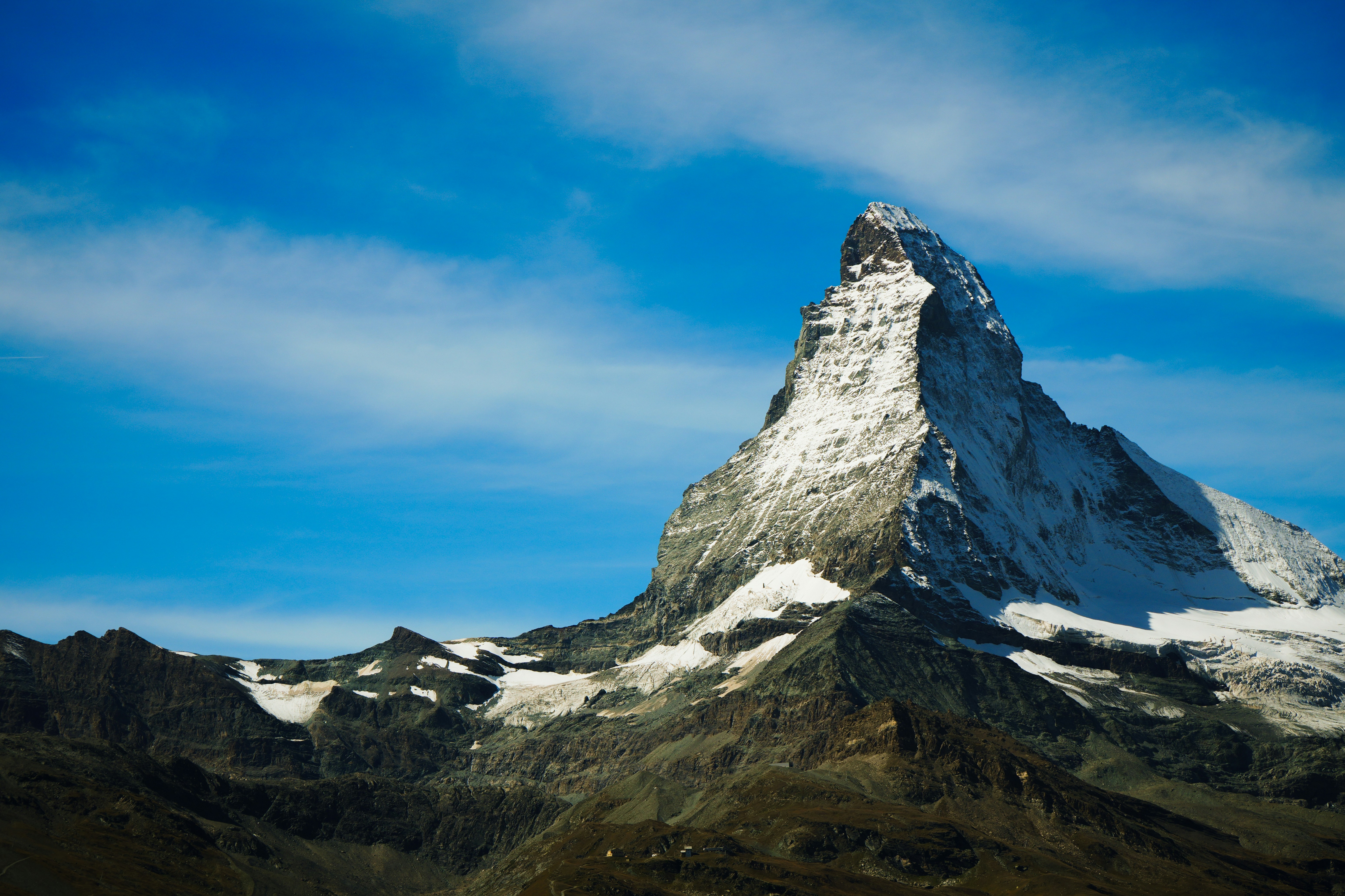 The Matterhorn peak with snow against a clear blue sky in Zermatt