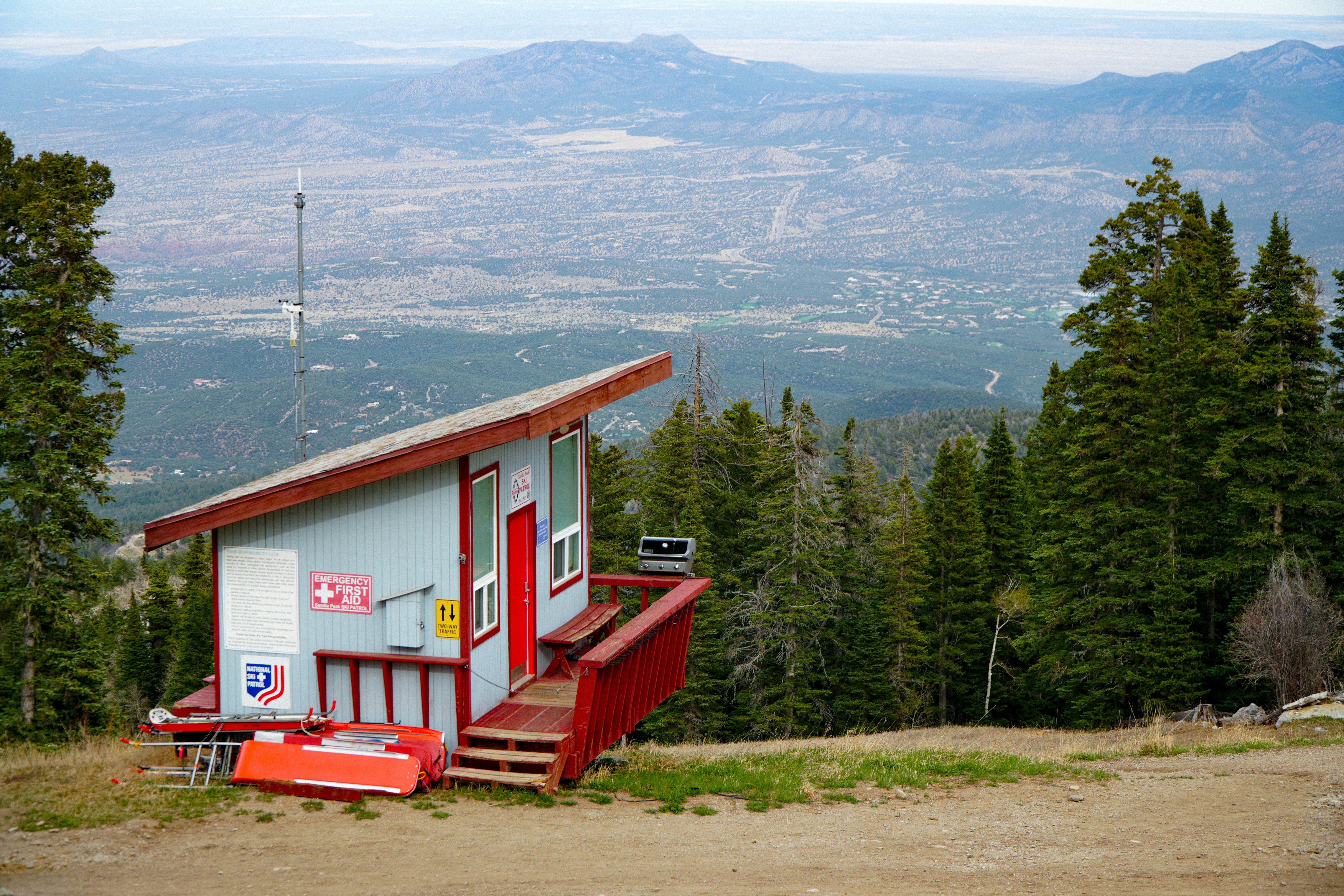 Red-rimmed Ski Hut Anchored on a Forested Slope