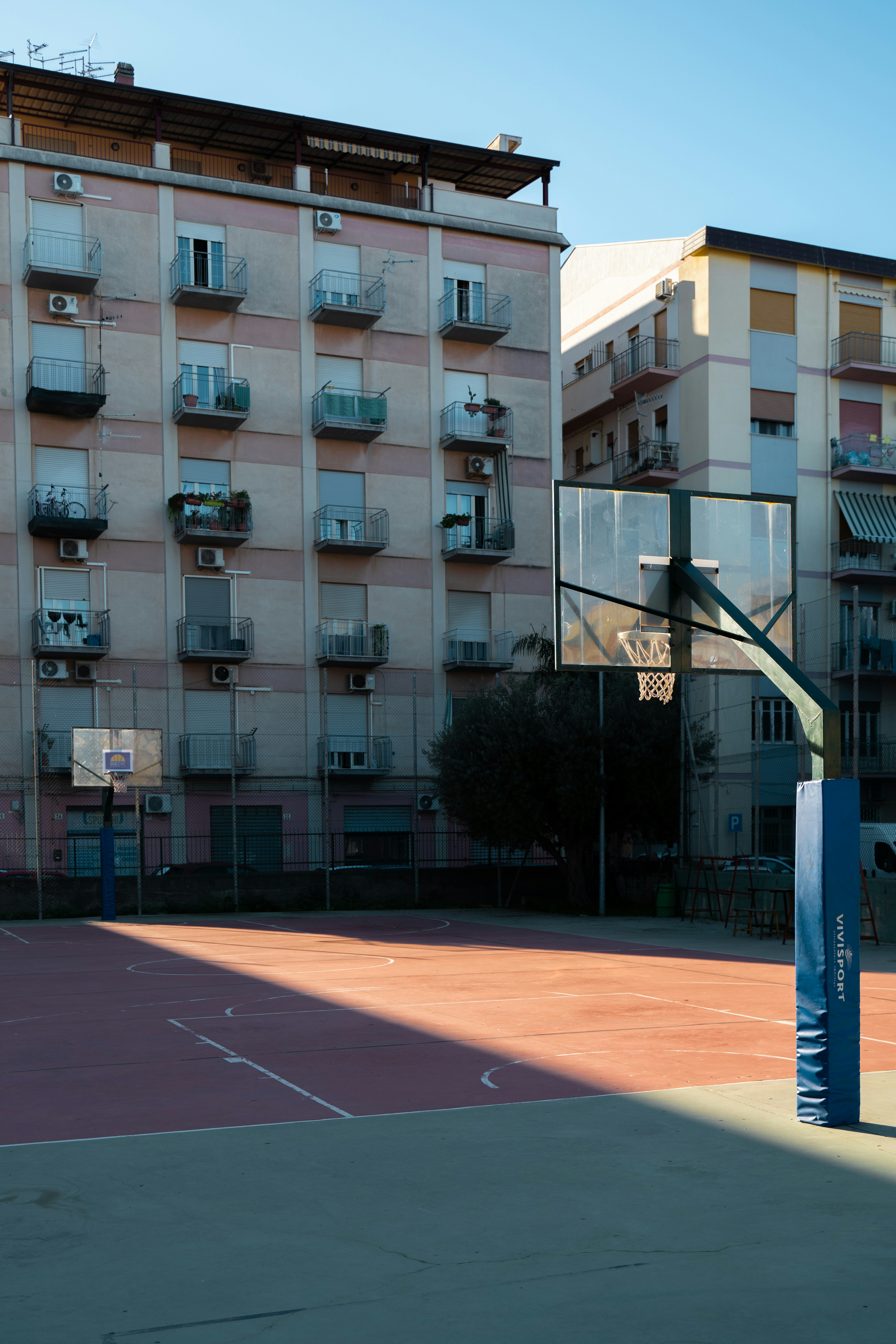 Sunlit Court at Dusk: A City Playground Basking in Geometry