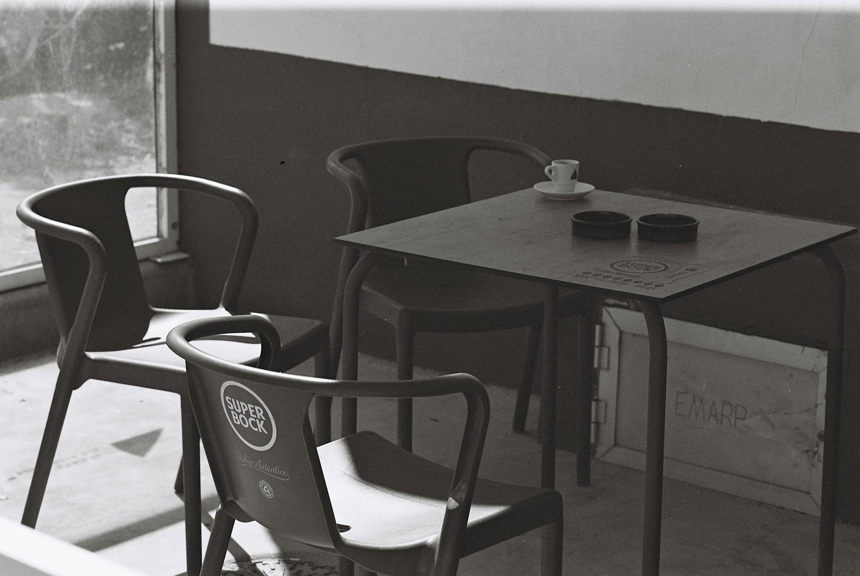 Quiet Corner: A Sunlit Café Scene in Monochrome