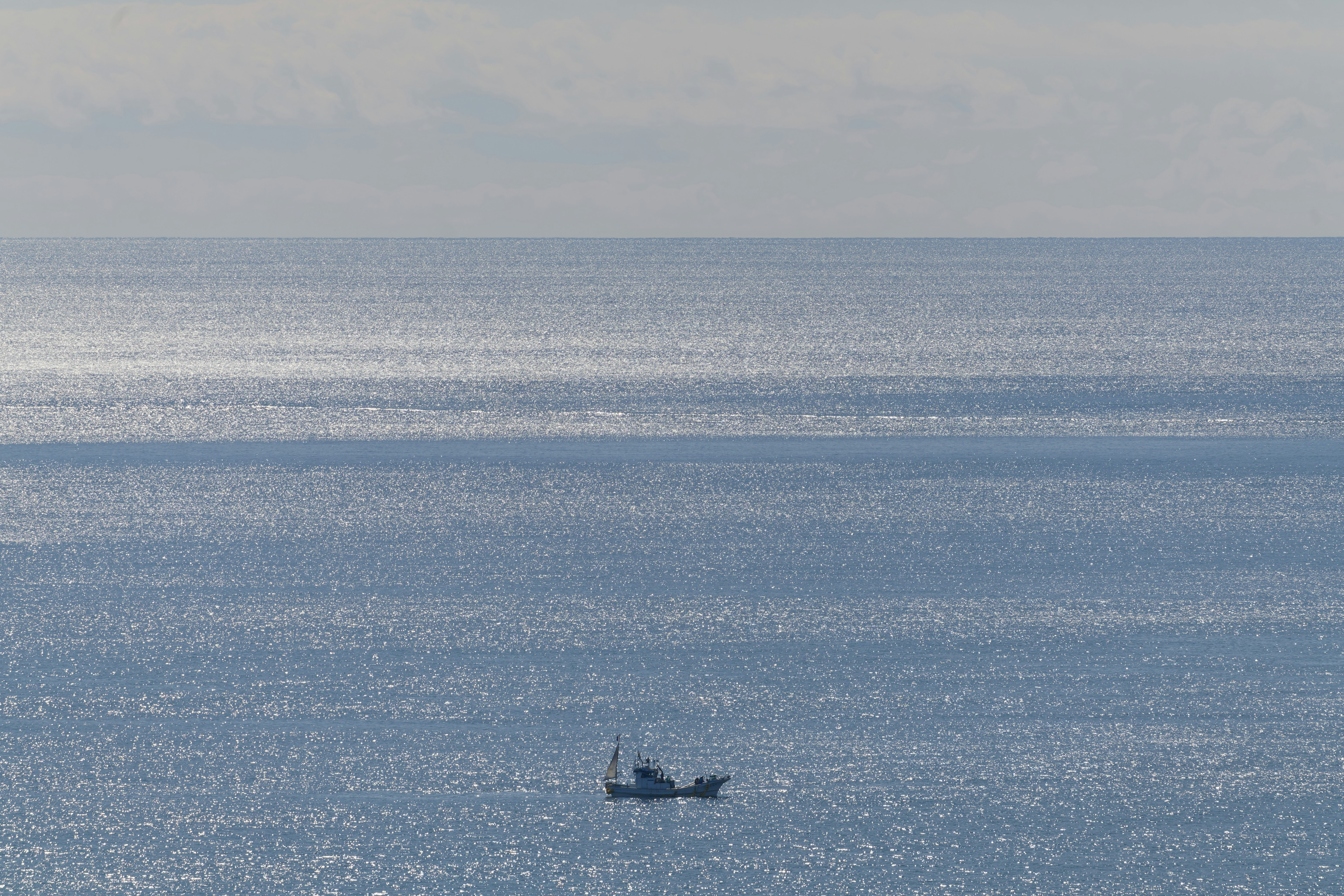 Low-Sun Sparkle on a Distant Hull