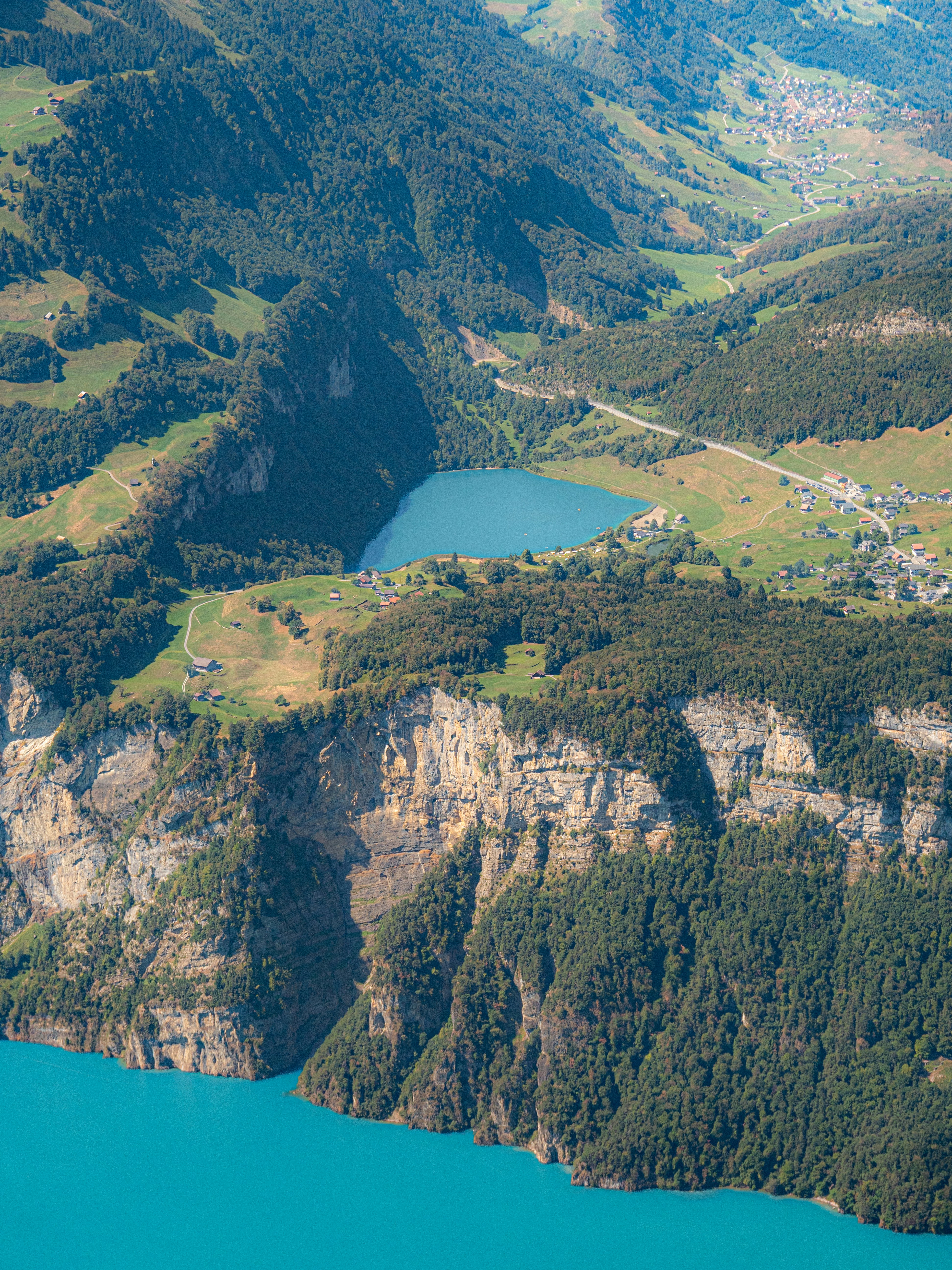 Aerial View of a Mountain Lake Nestled in Verdant Valleys
