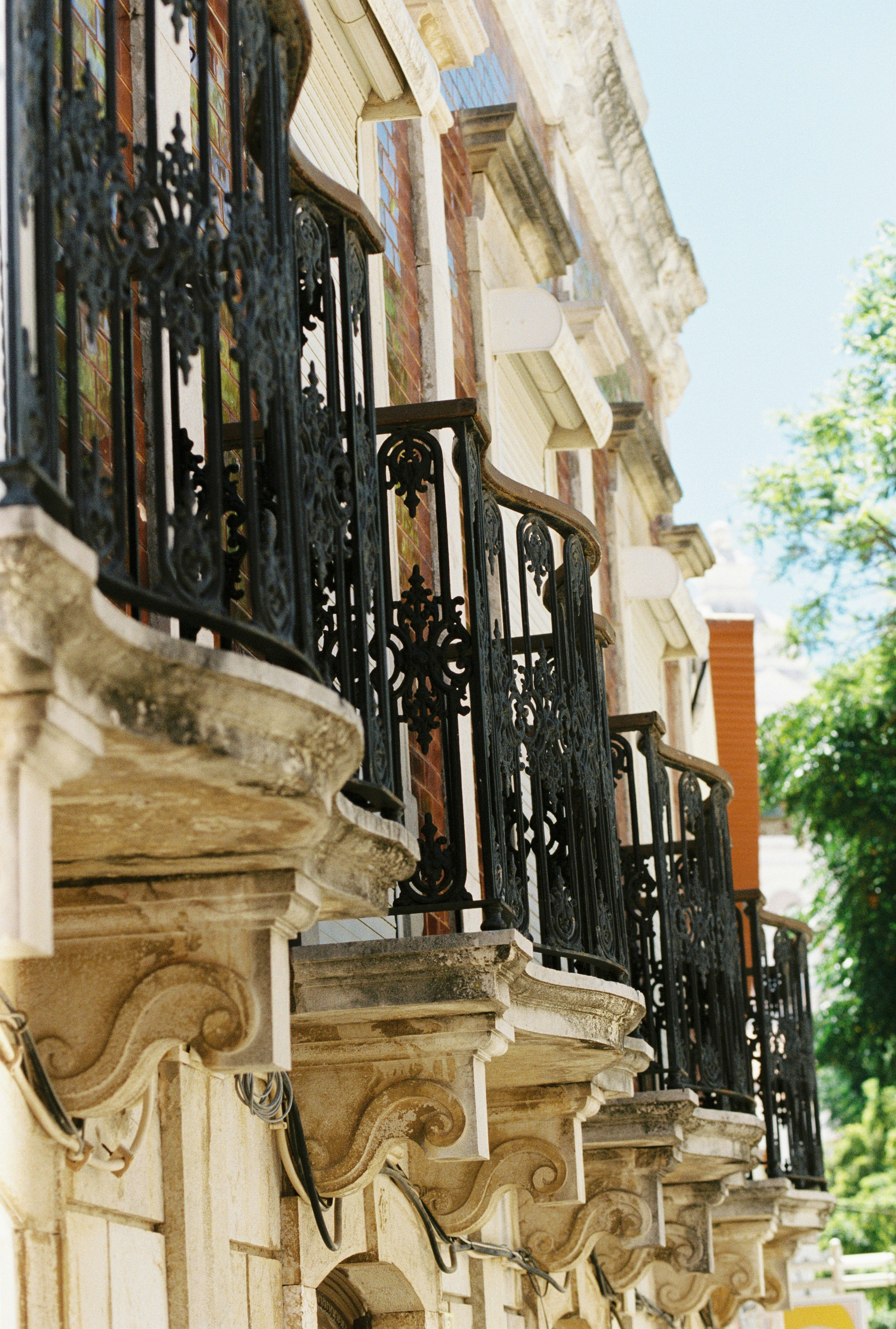 Ornate Balcony Railings: Stone Cornices and Cast Shadows