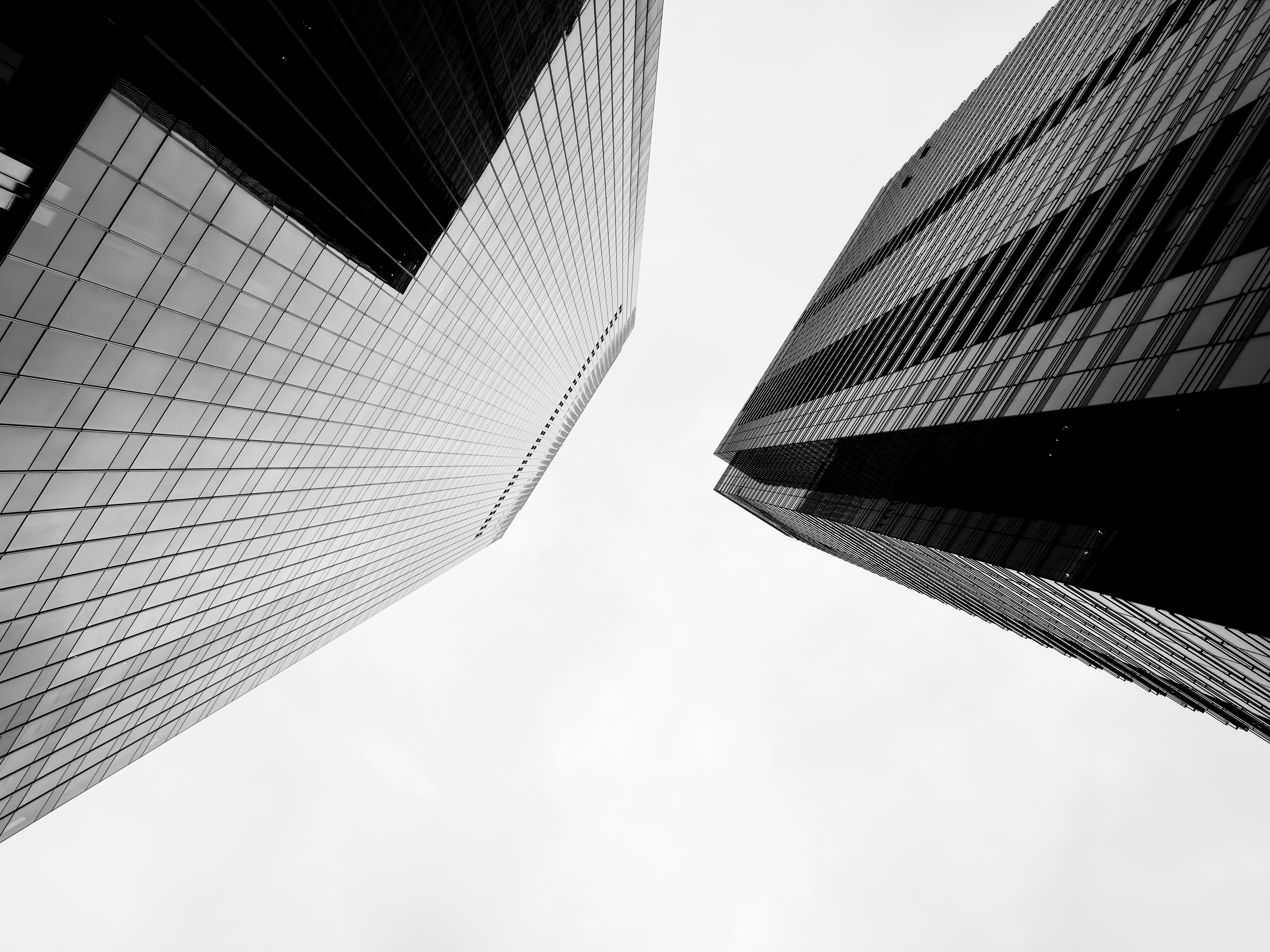 Monoliths from Below: A Geometric Dance of Glass and Sky