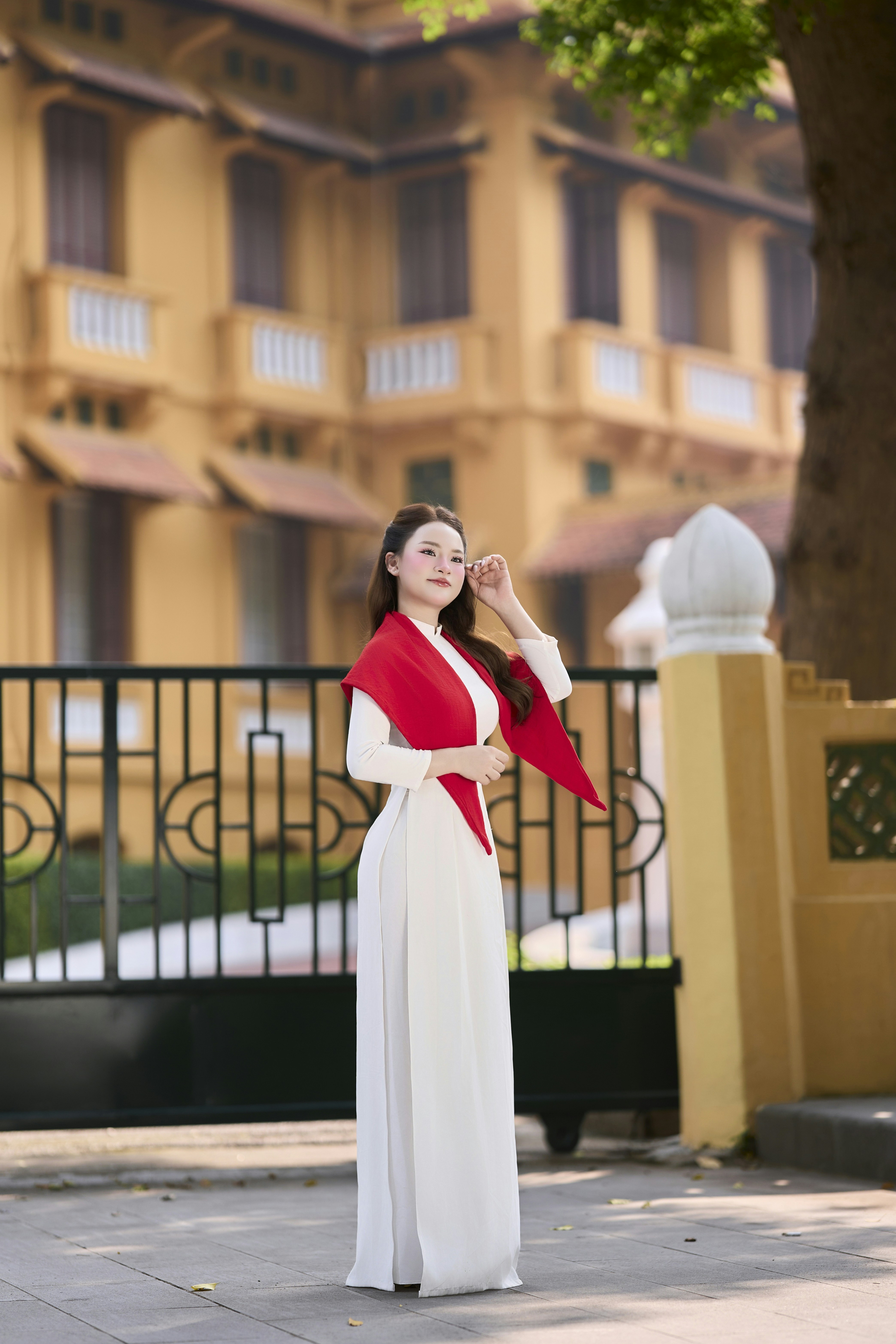 Grace in Red: A Portrait Before a Sunlit Courtyard