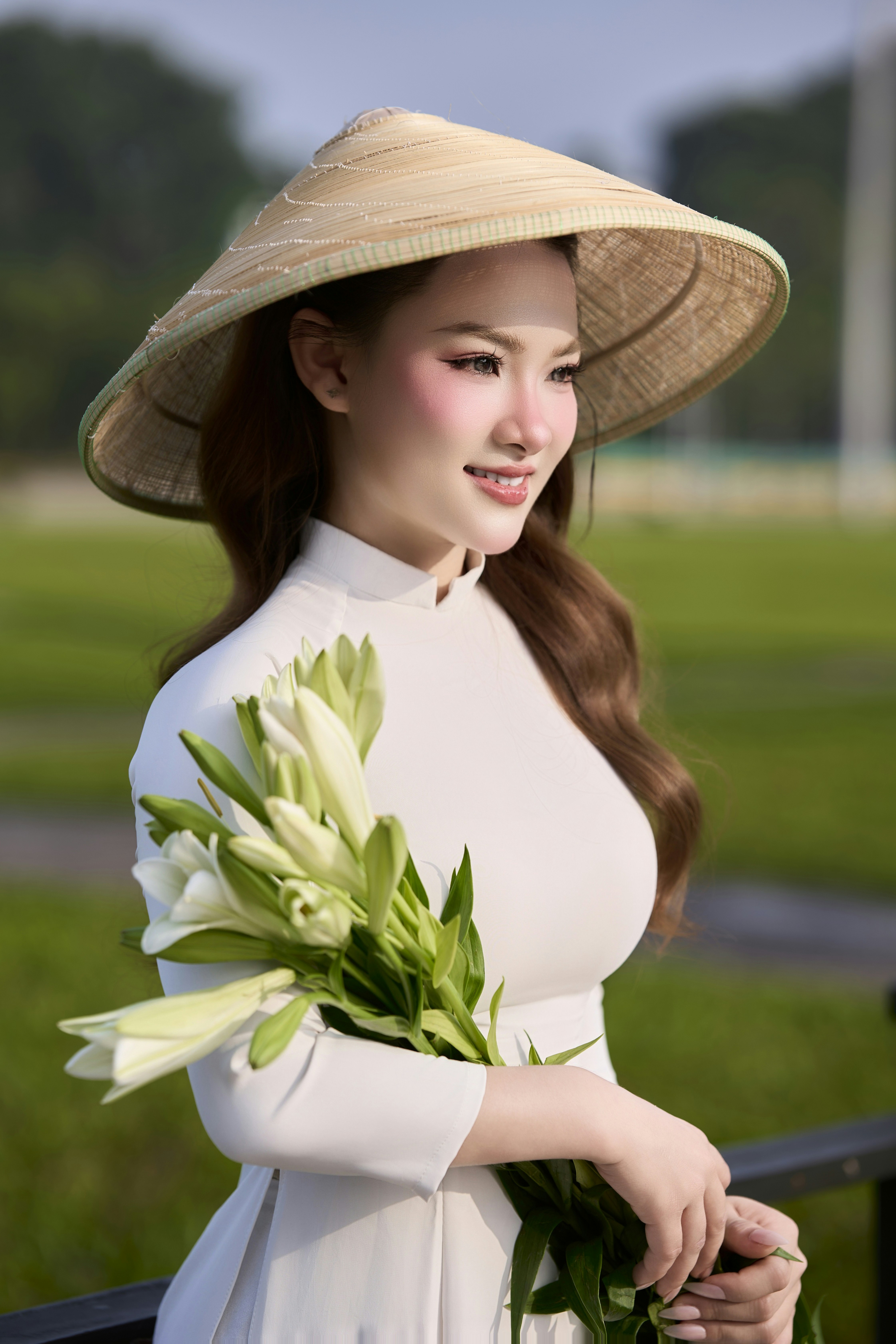 Sunlit Grace: A Portrait in White with a Straw Hat