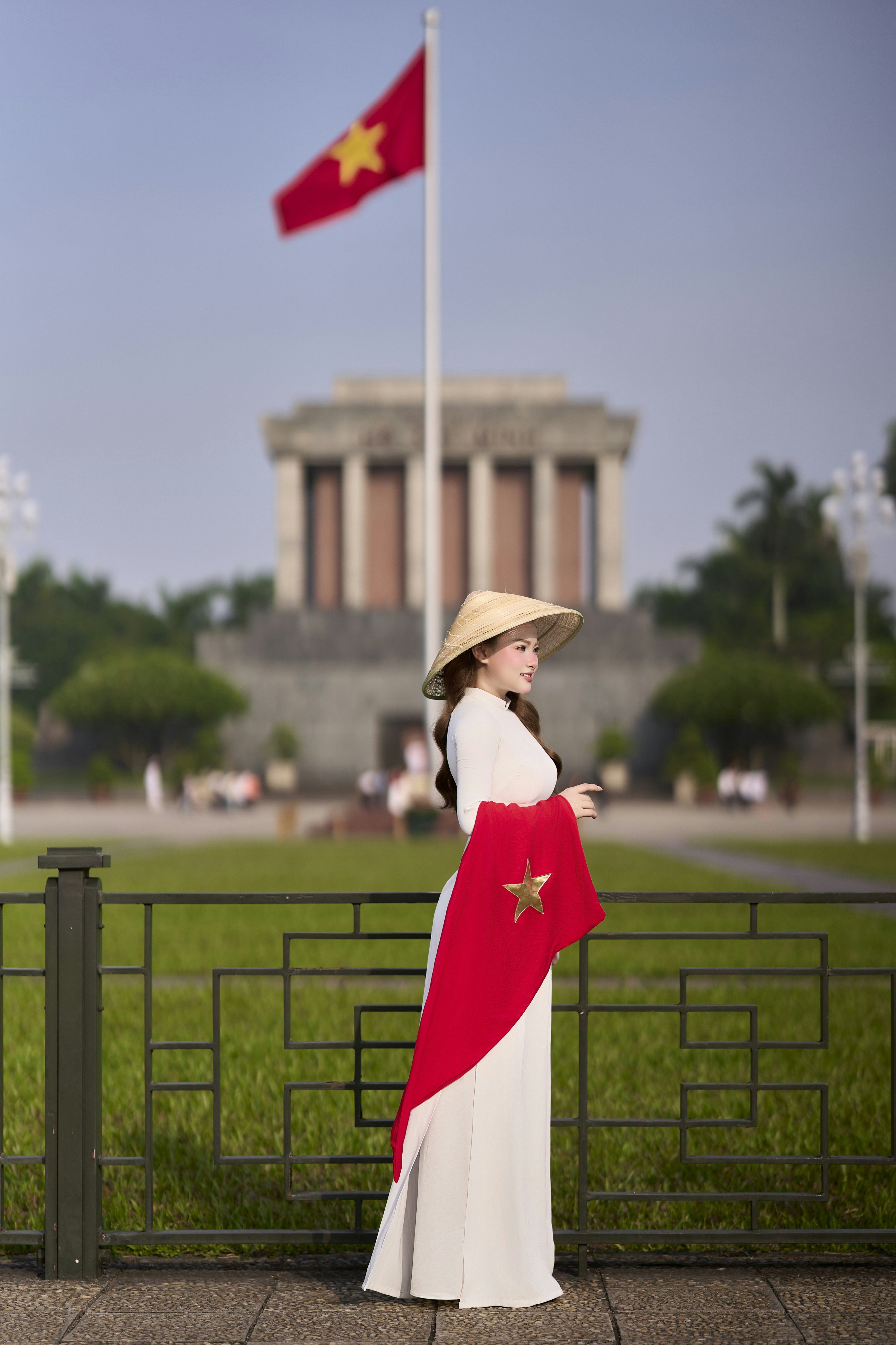 Flag and Veils of Red: A Portrait by the Gate