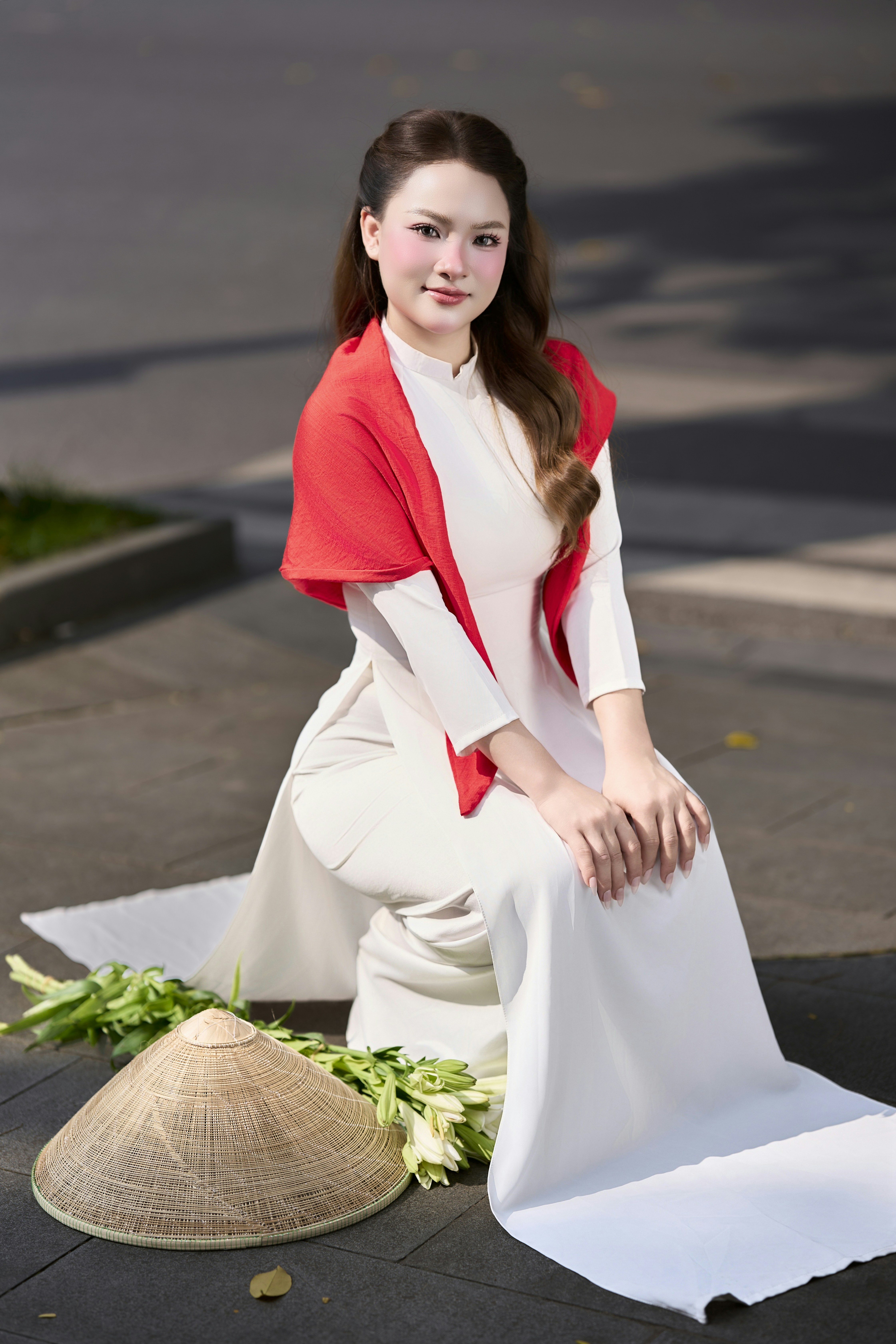 Grace in White: A Poised Moment with a Red Accent