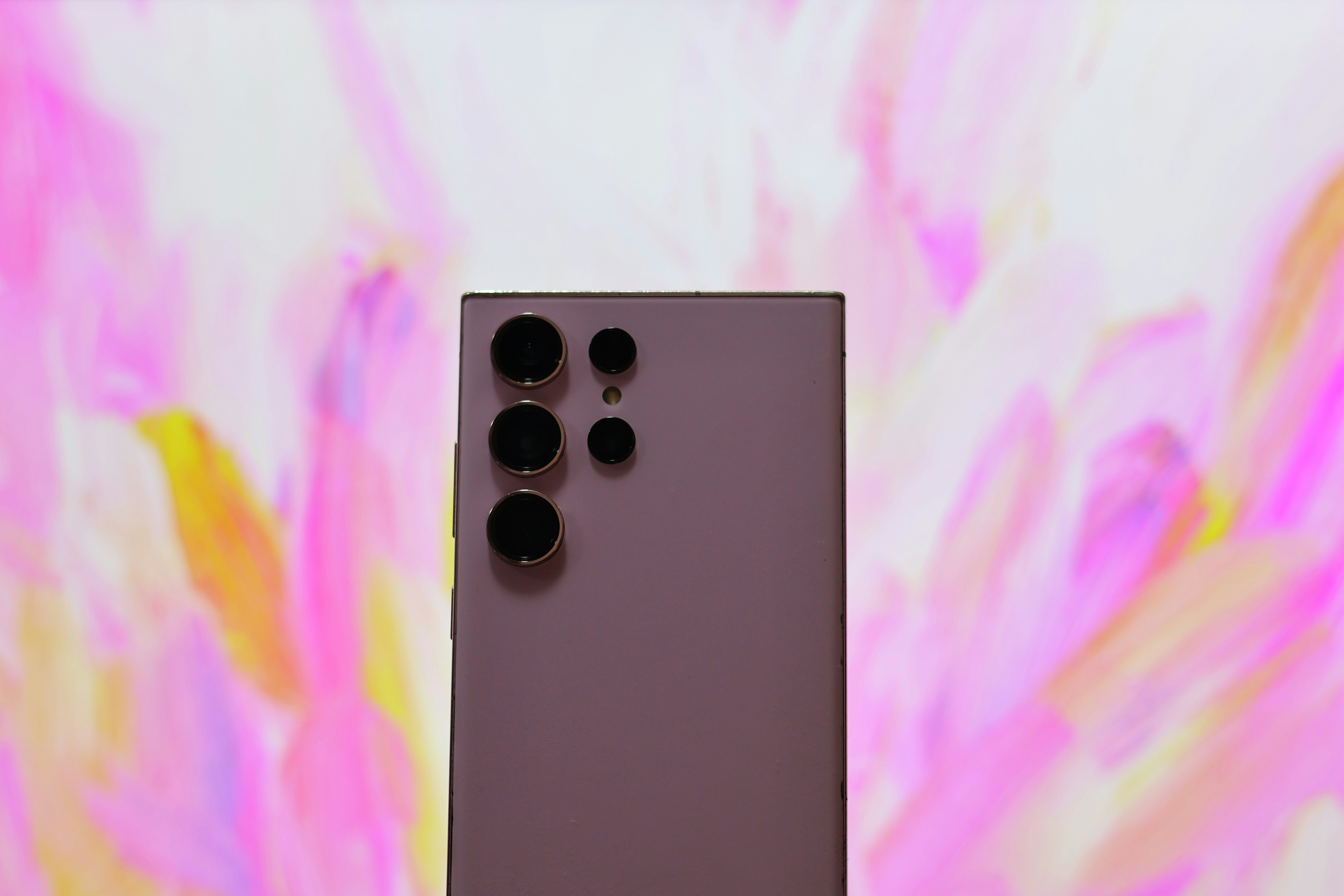 Mono Prism: A Midnight Purple Galaxy S22 Ultra-like Back Panel with Camera Array Against Abstract Pastel Backdrop
