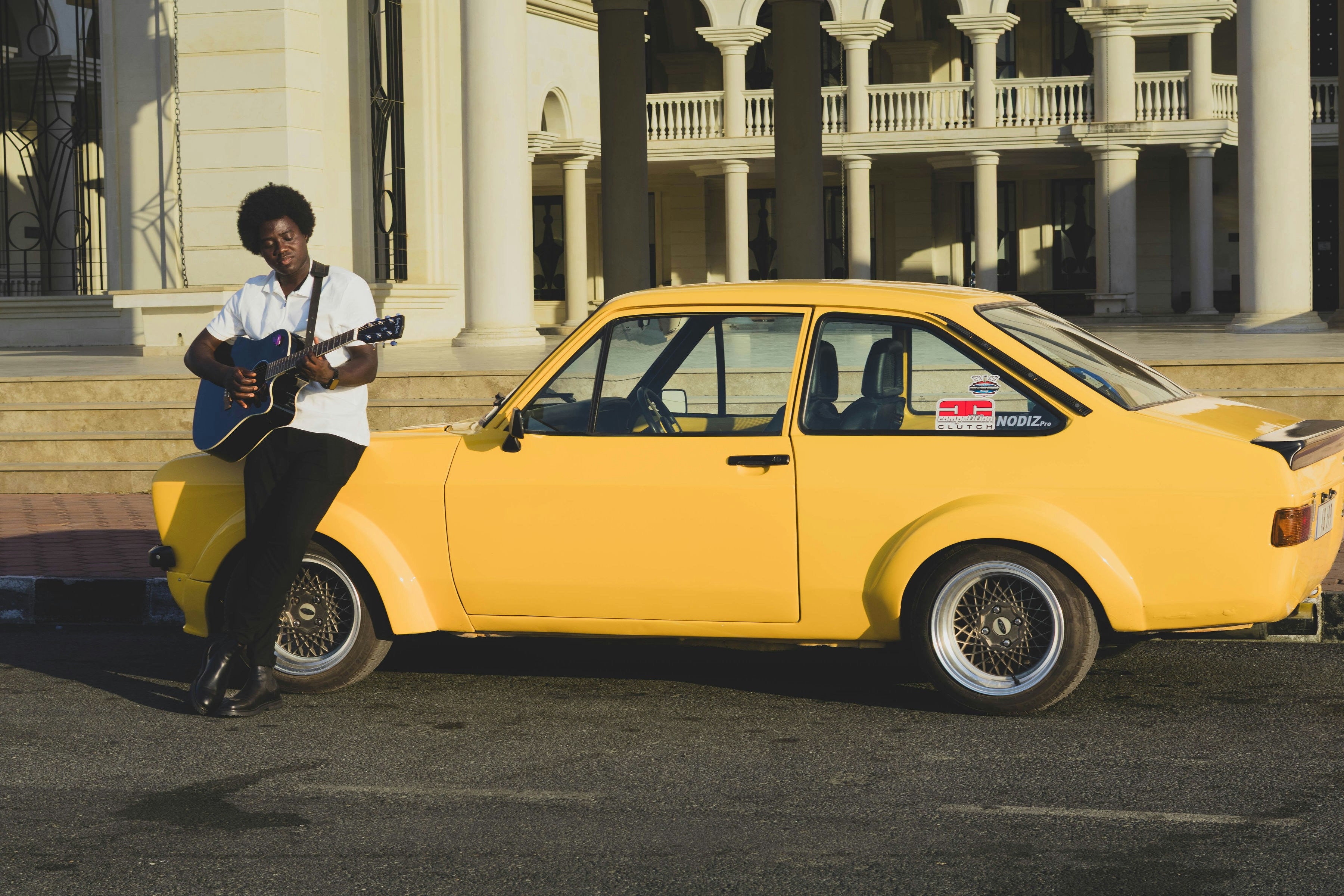 Guitarist by the Yellow Classic: Street Serene in a Sunlit Alley