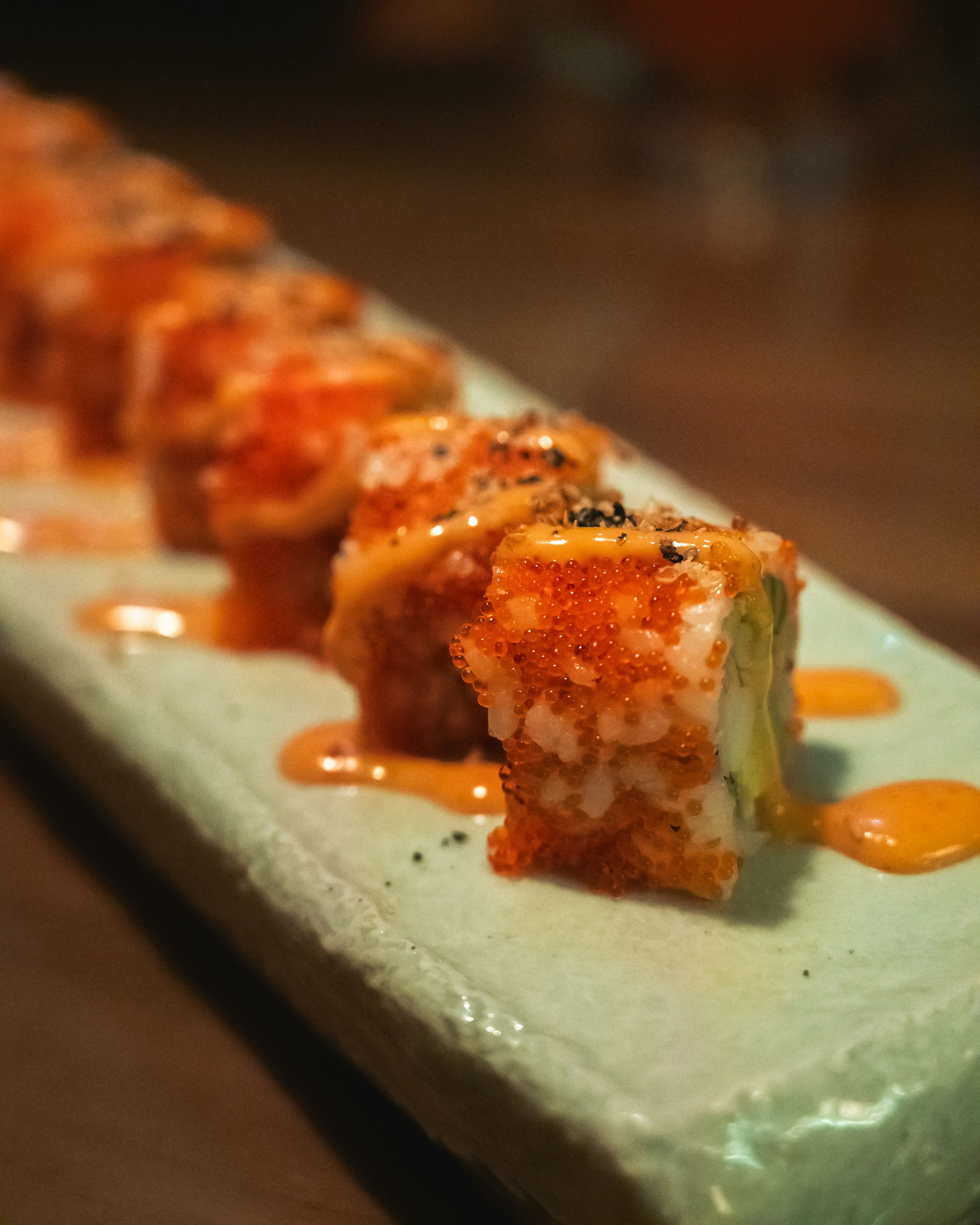 Nigiri-Forward Crispy Roll on a Pale Ceramic Drift