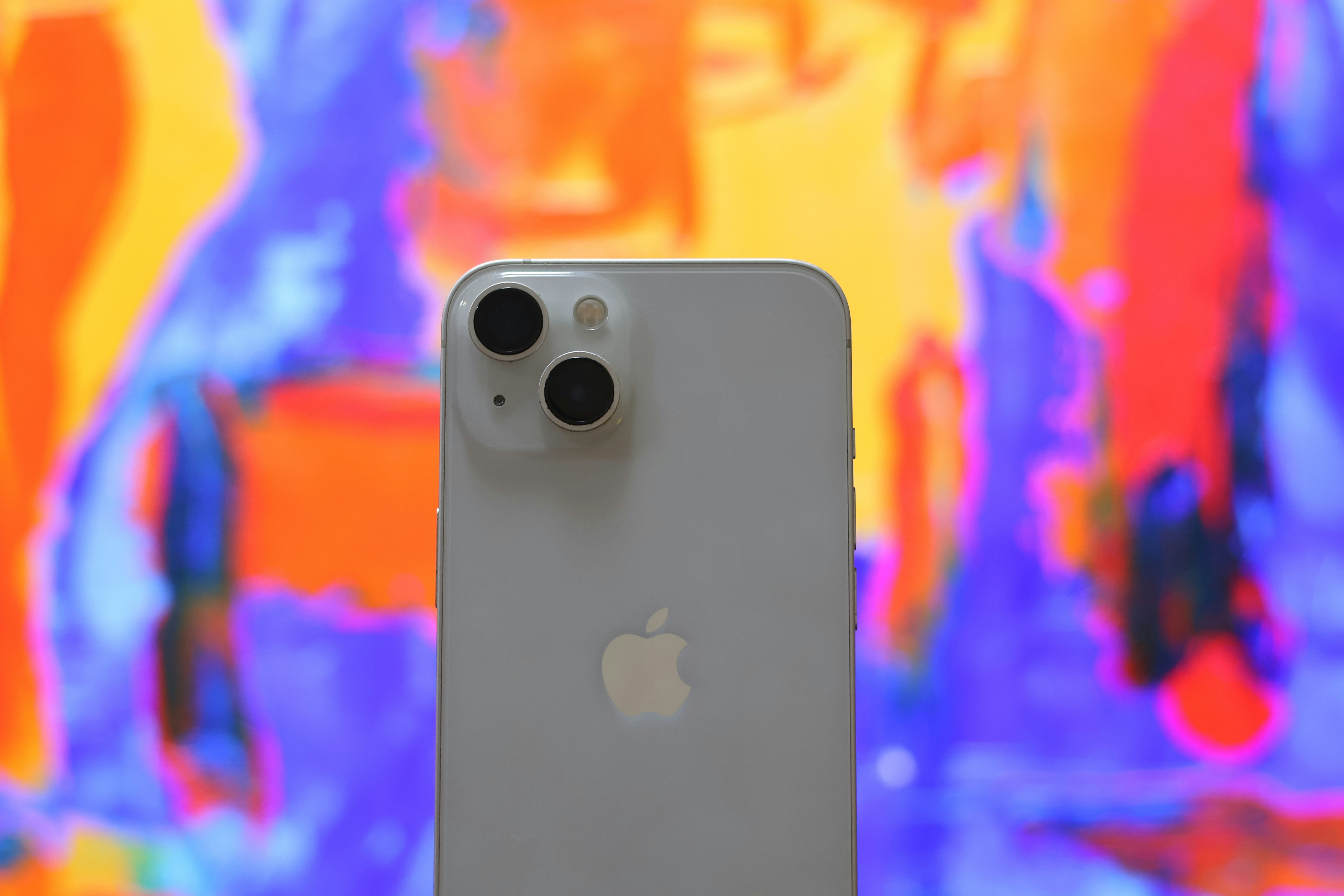 Abstract Portrait of Technology: A Close-Up of an iPhone Against Colorful Blur