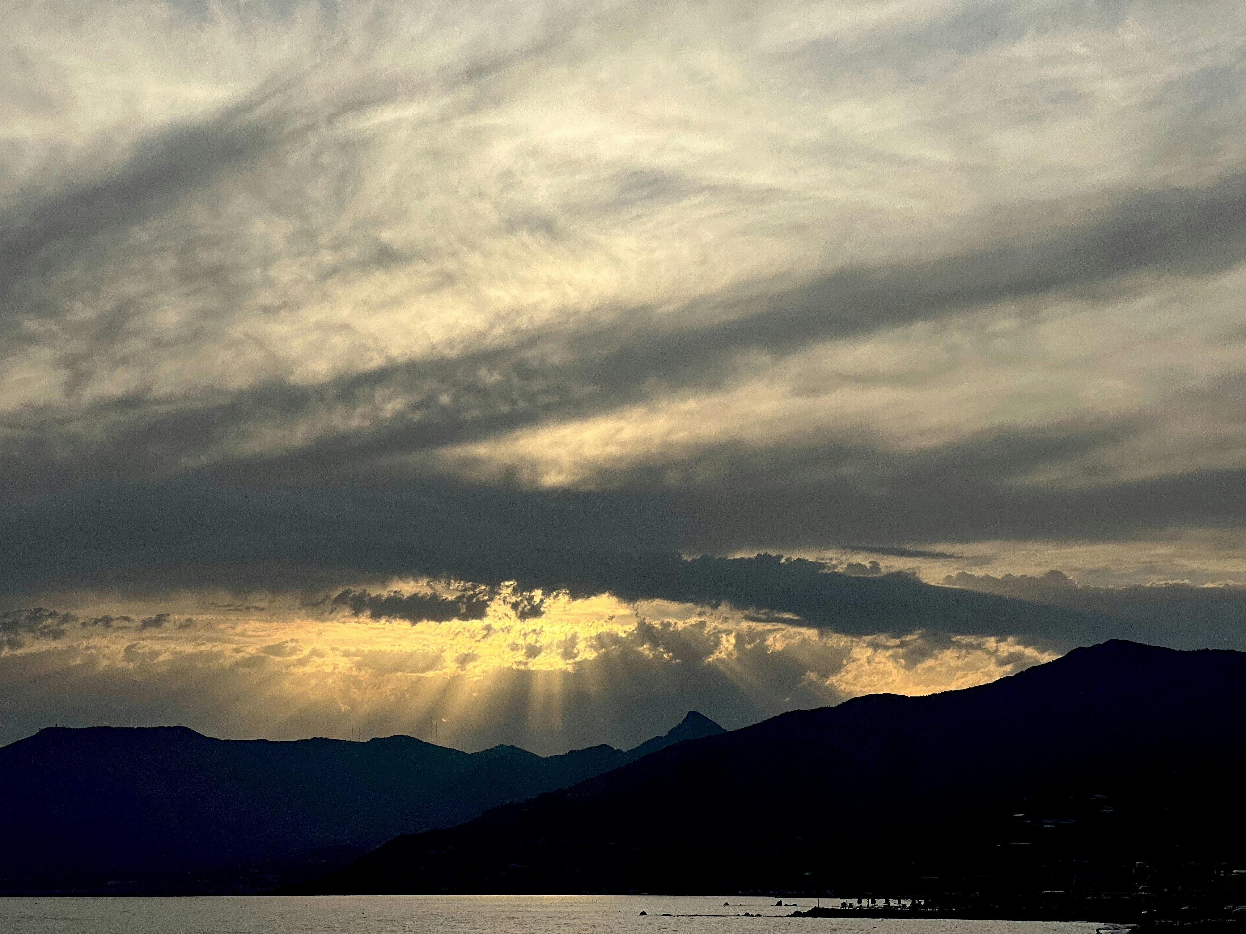 Dawn Over Quiet Peaks: Sunbreak Through the Valley