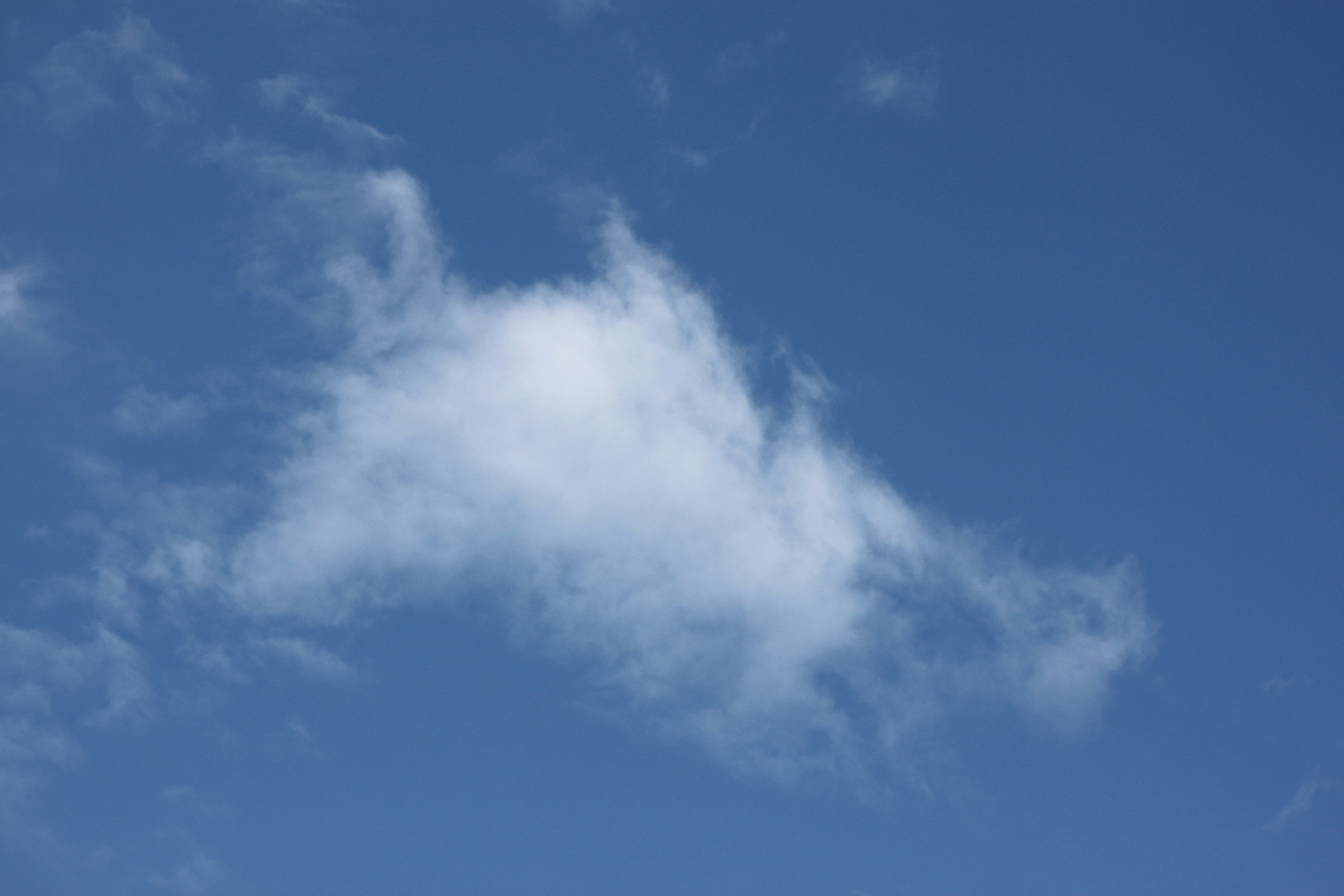 A Lone Cloud Drifting Across a Cerulean Sky