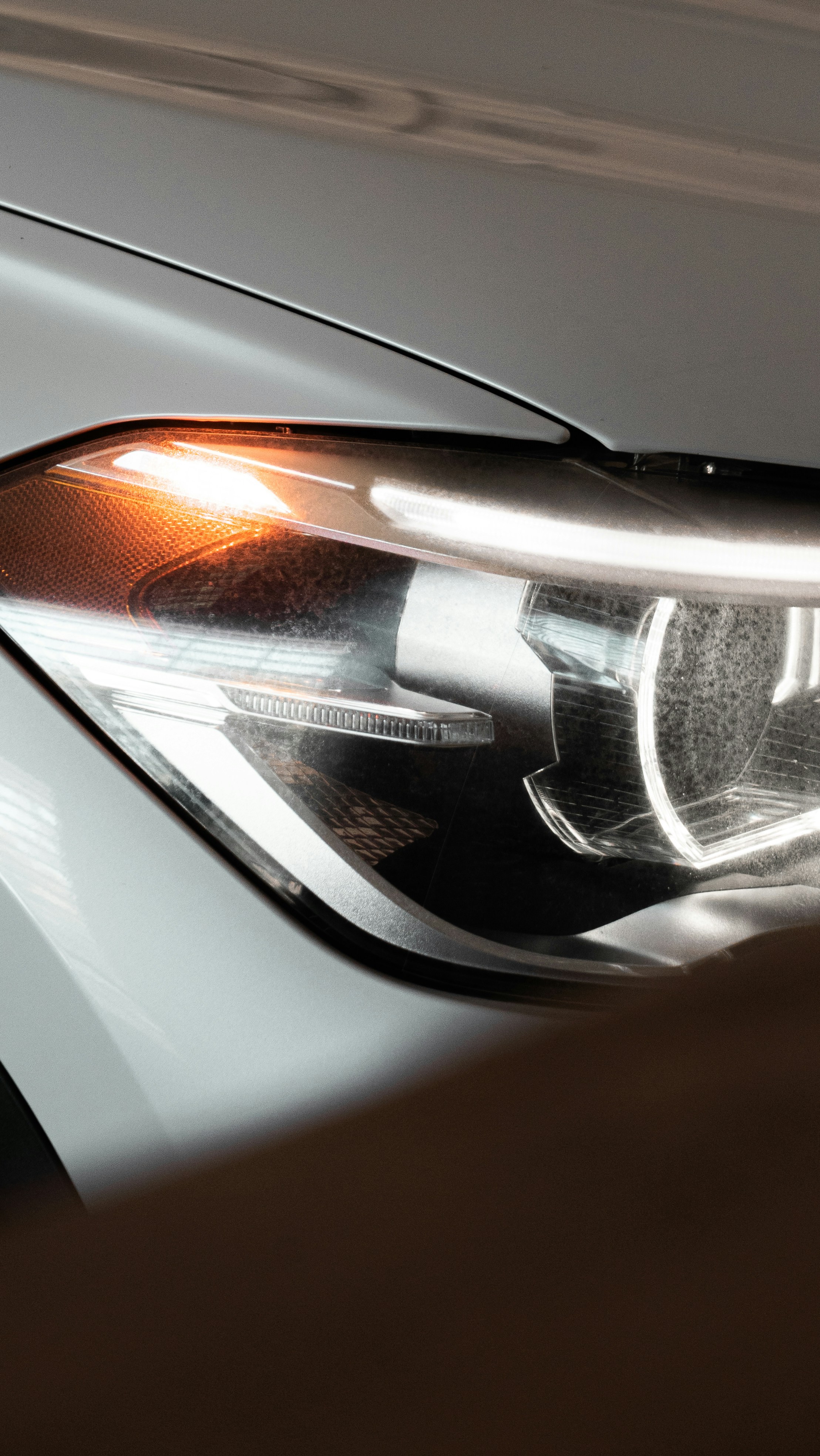 Close-Quarters Headlight Detail on a Silver Vehicle